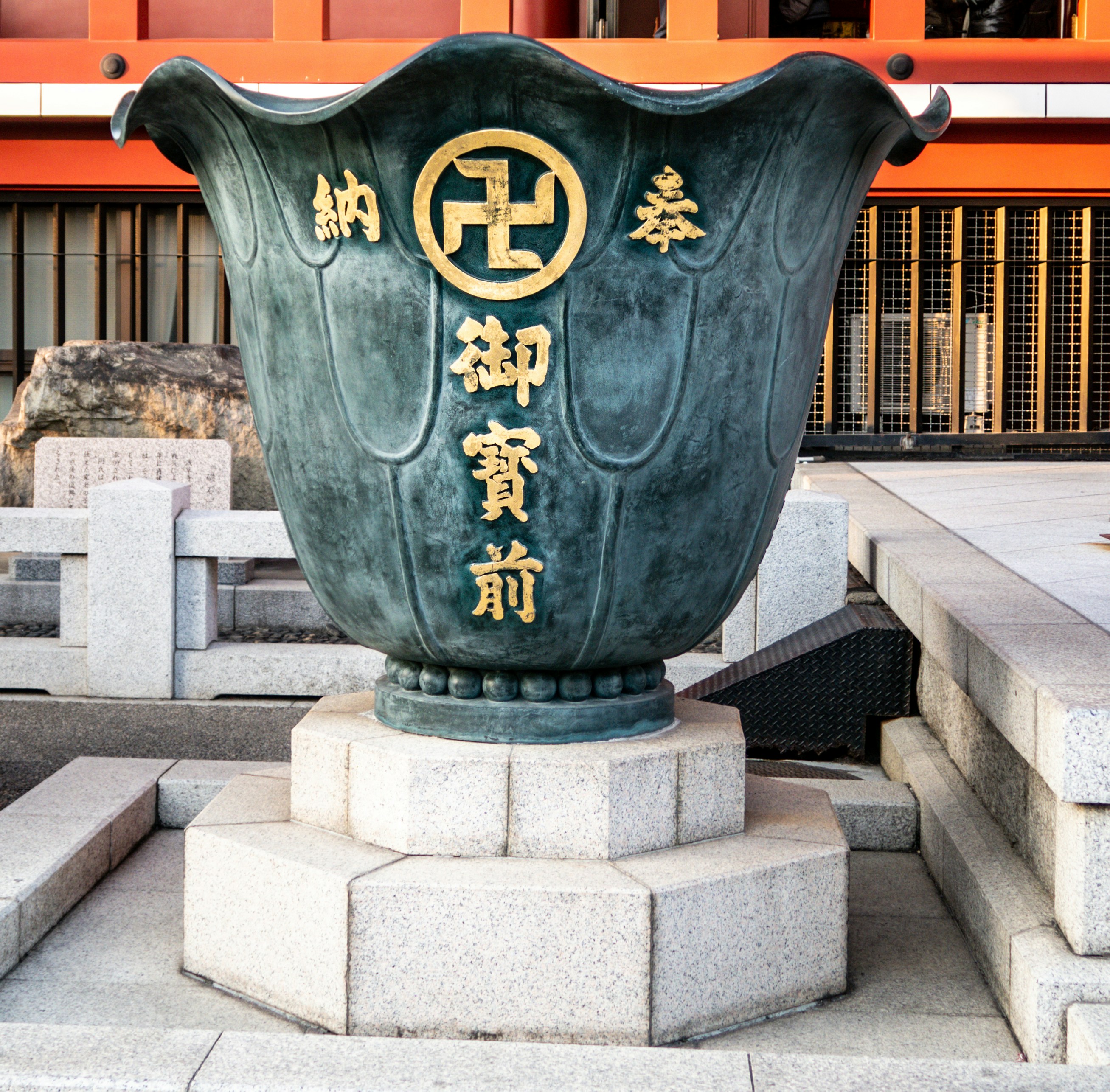 a large green vase sitting on top of a stone slab