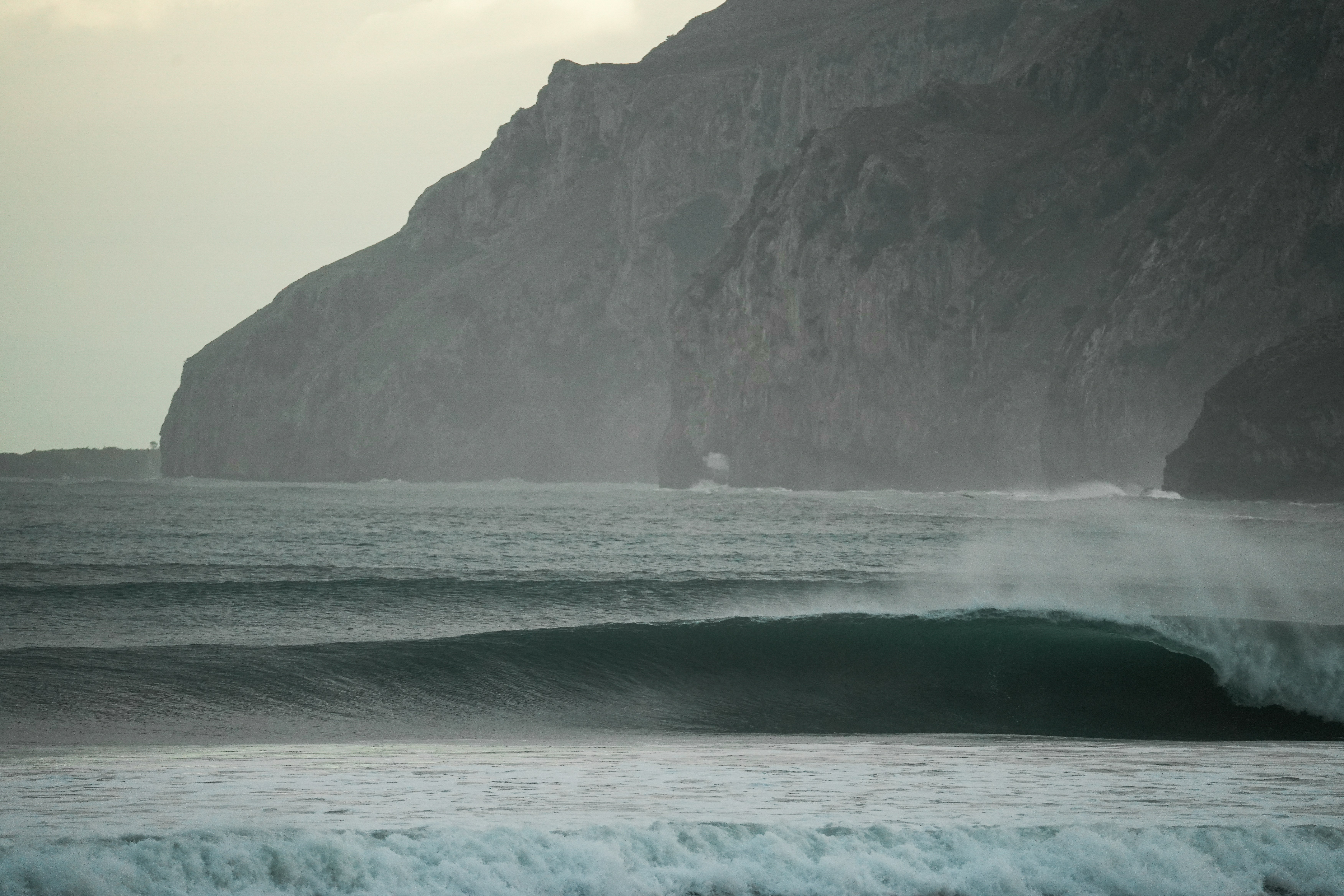 Green Barrel Break by the Cliffs at Dusk