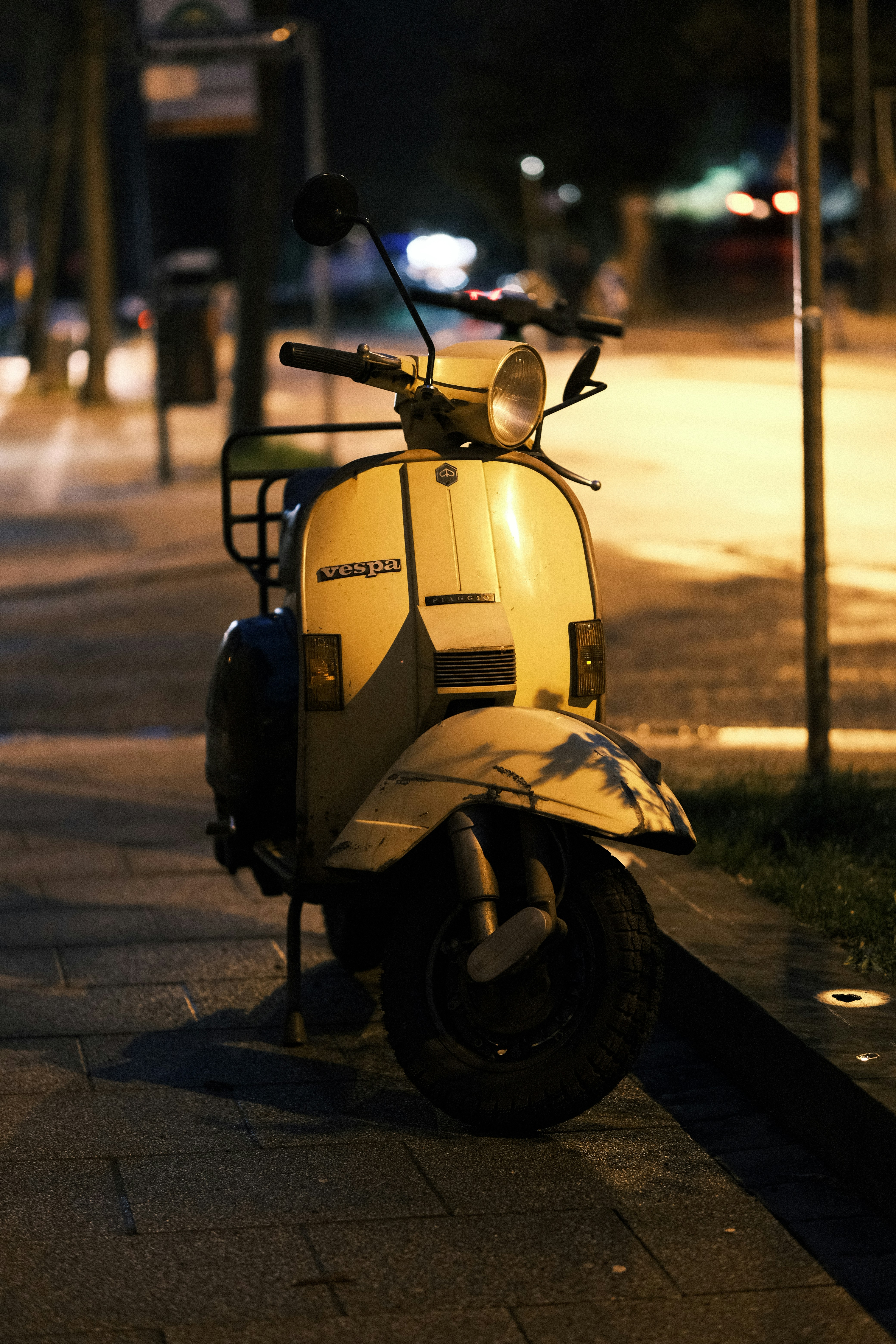 Night-Glow Vespa: a yellow scooter bathed in amber streetlight