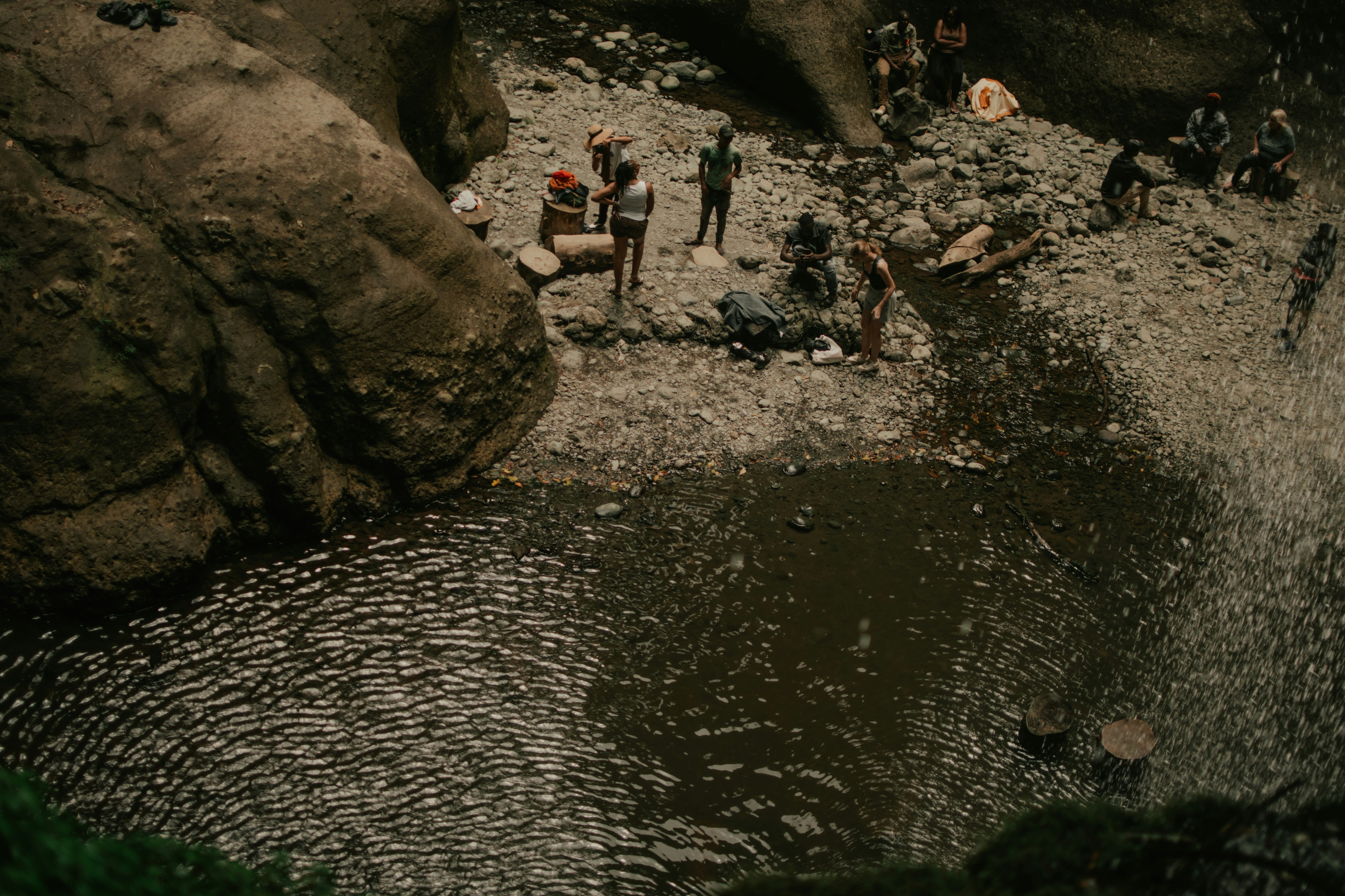 a group of people standing on top of a river