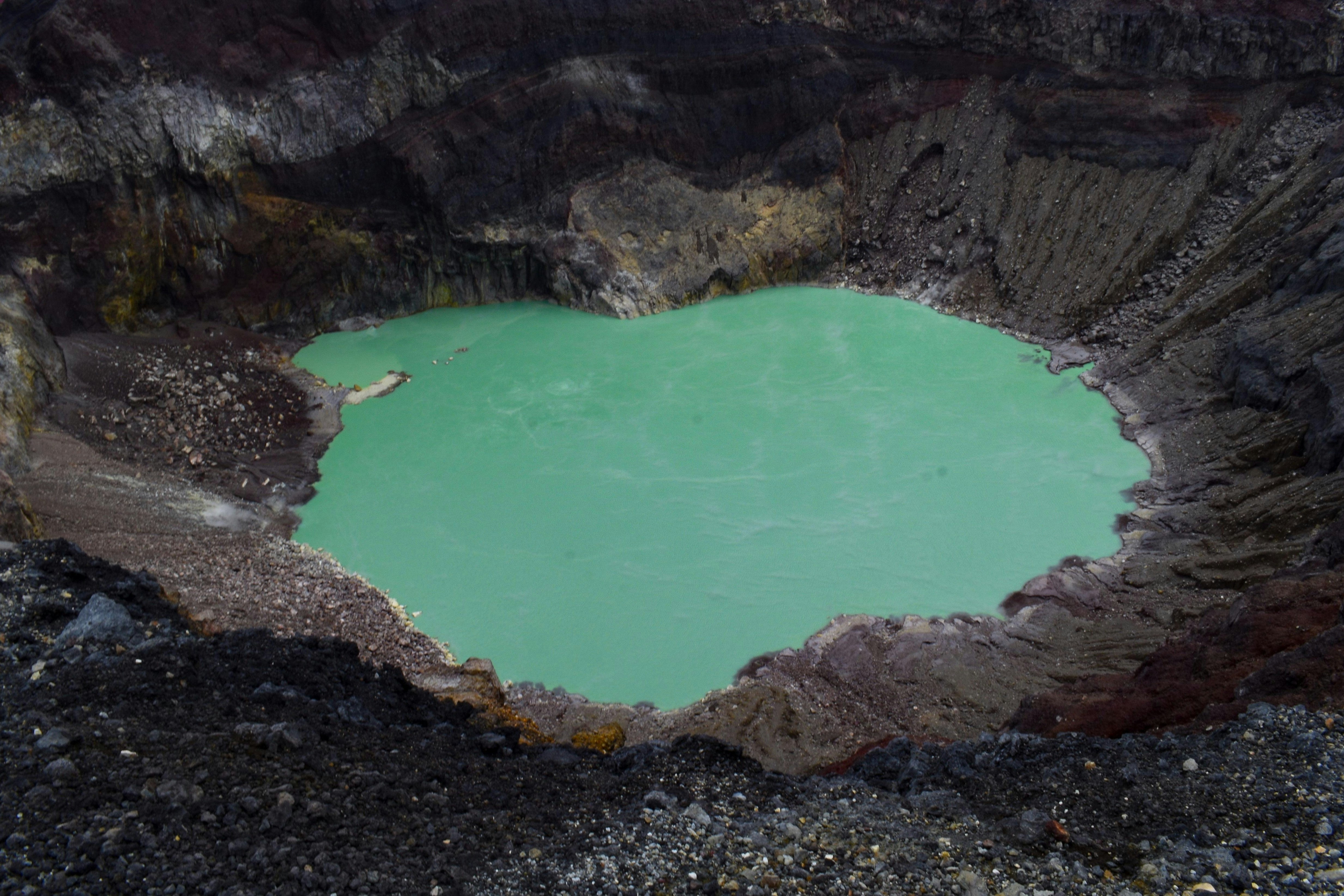 A heart shaped hole in the middle of a mountain photo – Free Volcano ...