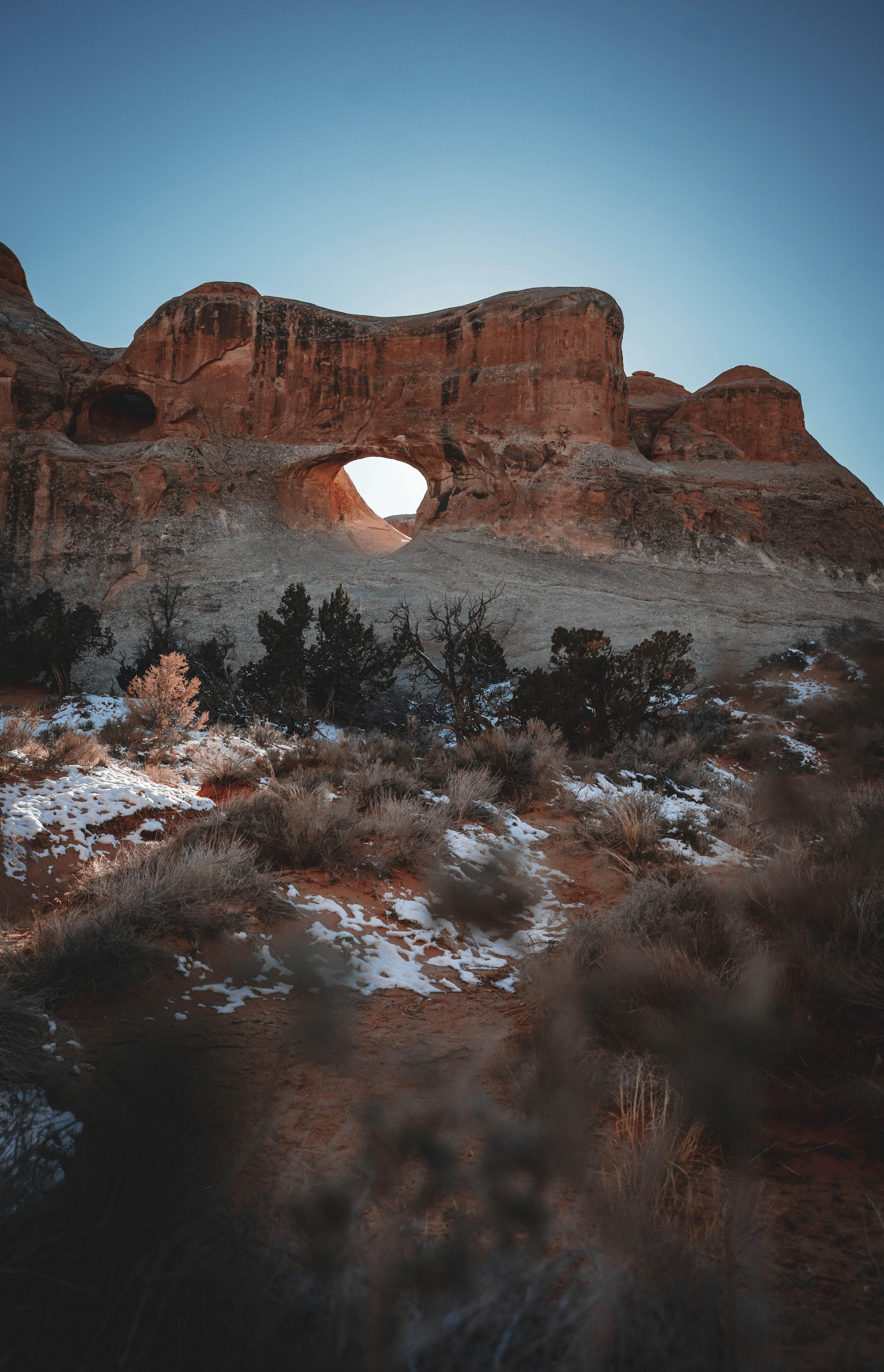The Stone Gateway: Snow-Kissed Desert Arch at Dusk