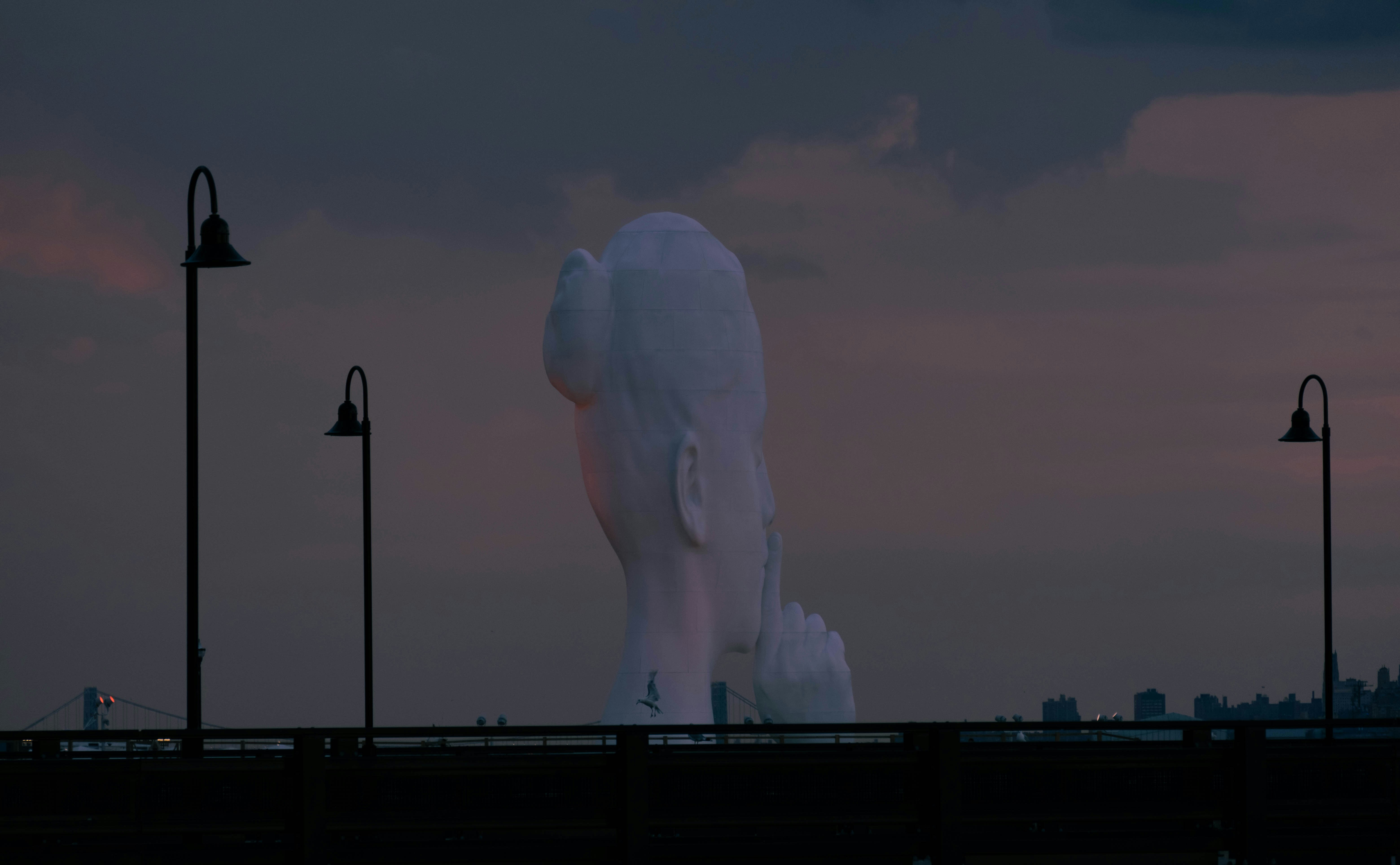 Dusk-Lit Statue Guarding a Silent Pier