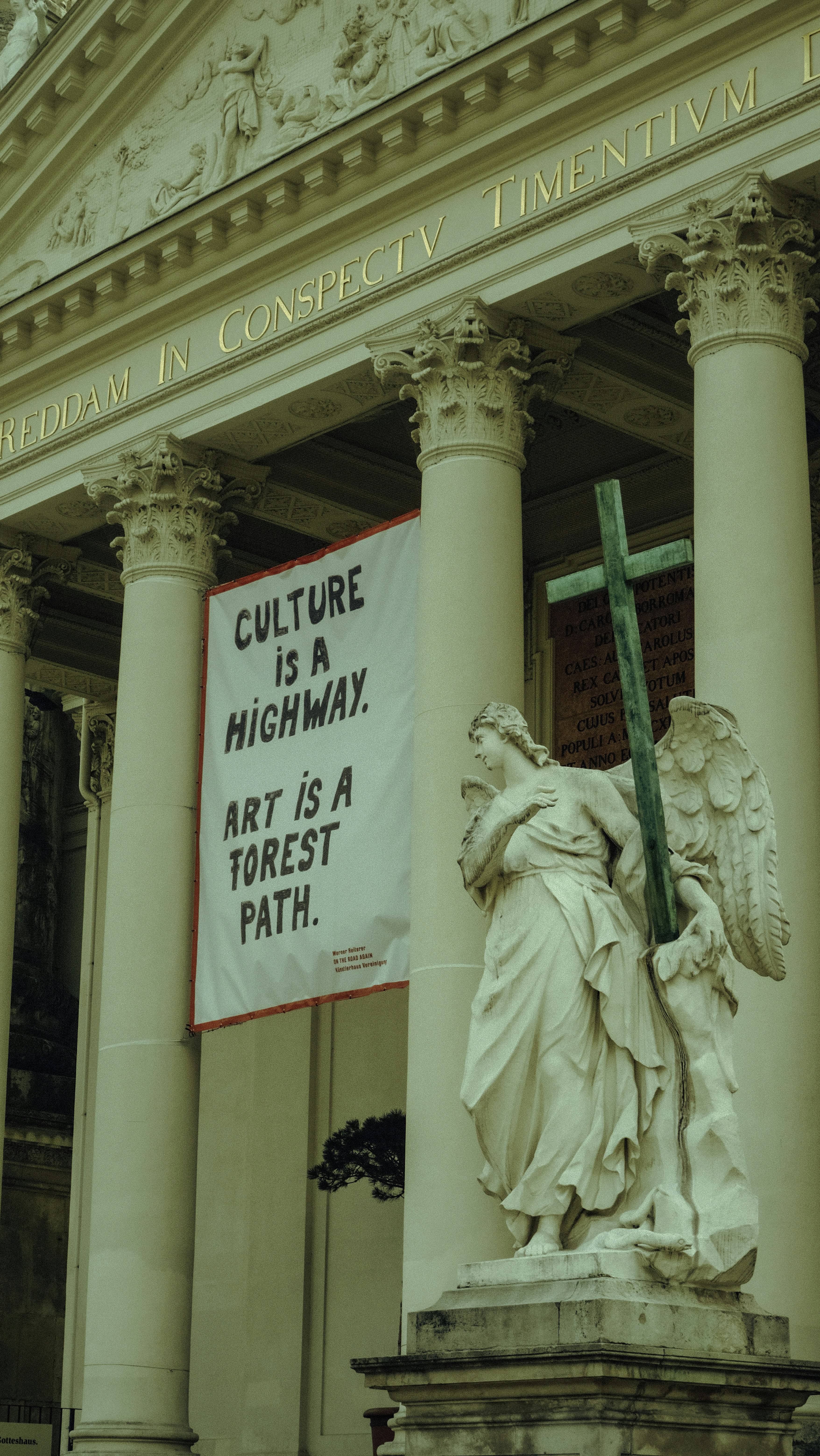Guardian of Culture: Banner and Angel at the Classic Facade