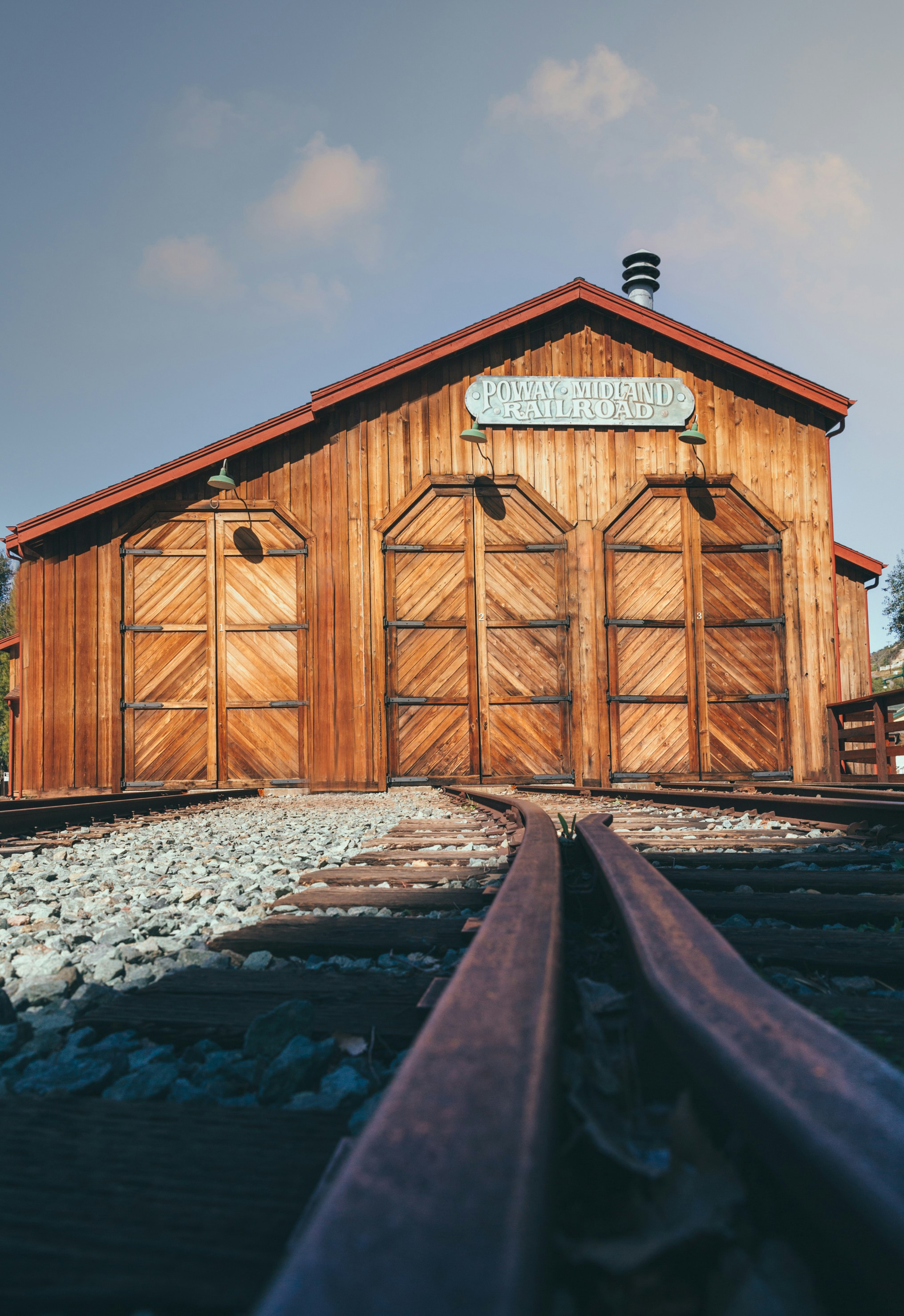 Front Facade of Poway-Midland Freight Barn Framed by Weathered Rails