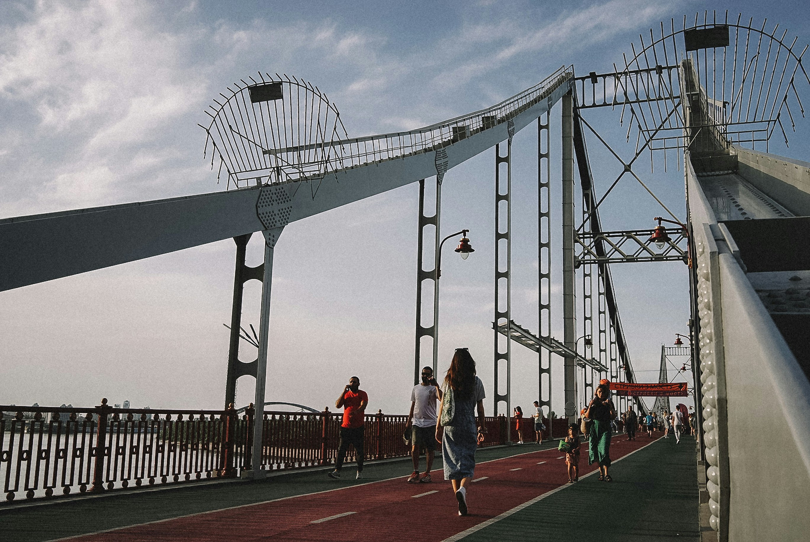 A group of people walking across a bridge photo – Free Basketball Image ...