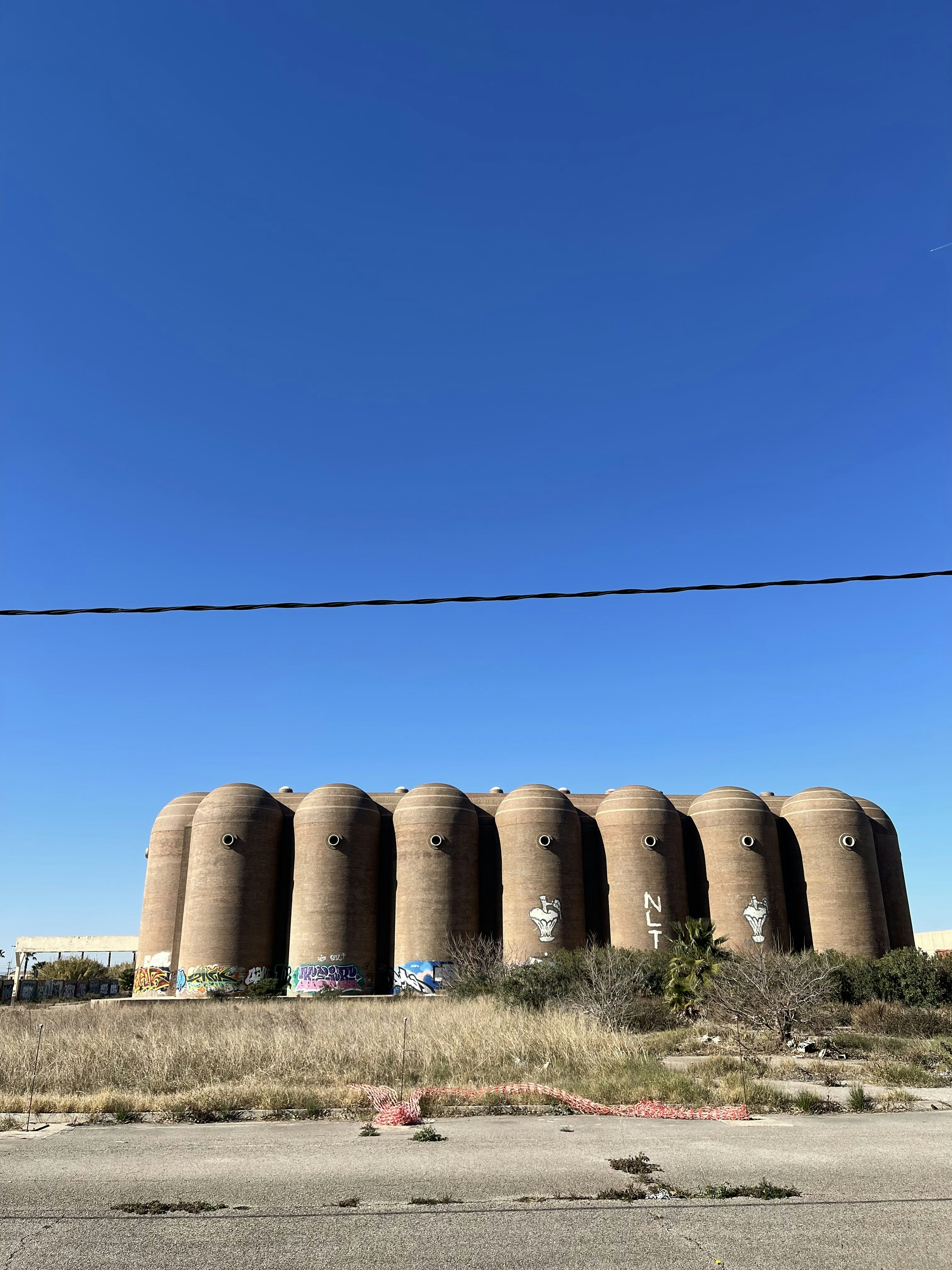 A row of cement silos sitting next to a road photo – Free Valencia ...