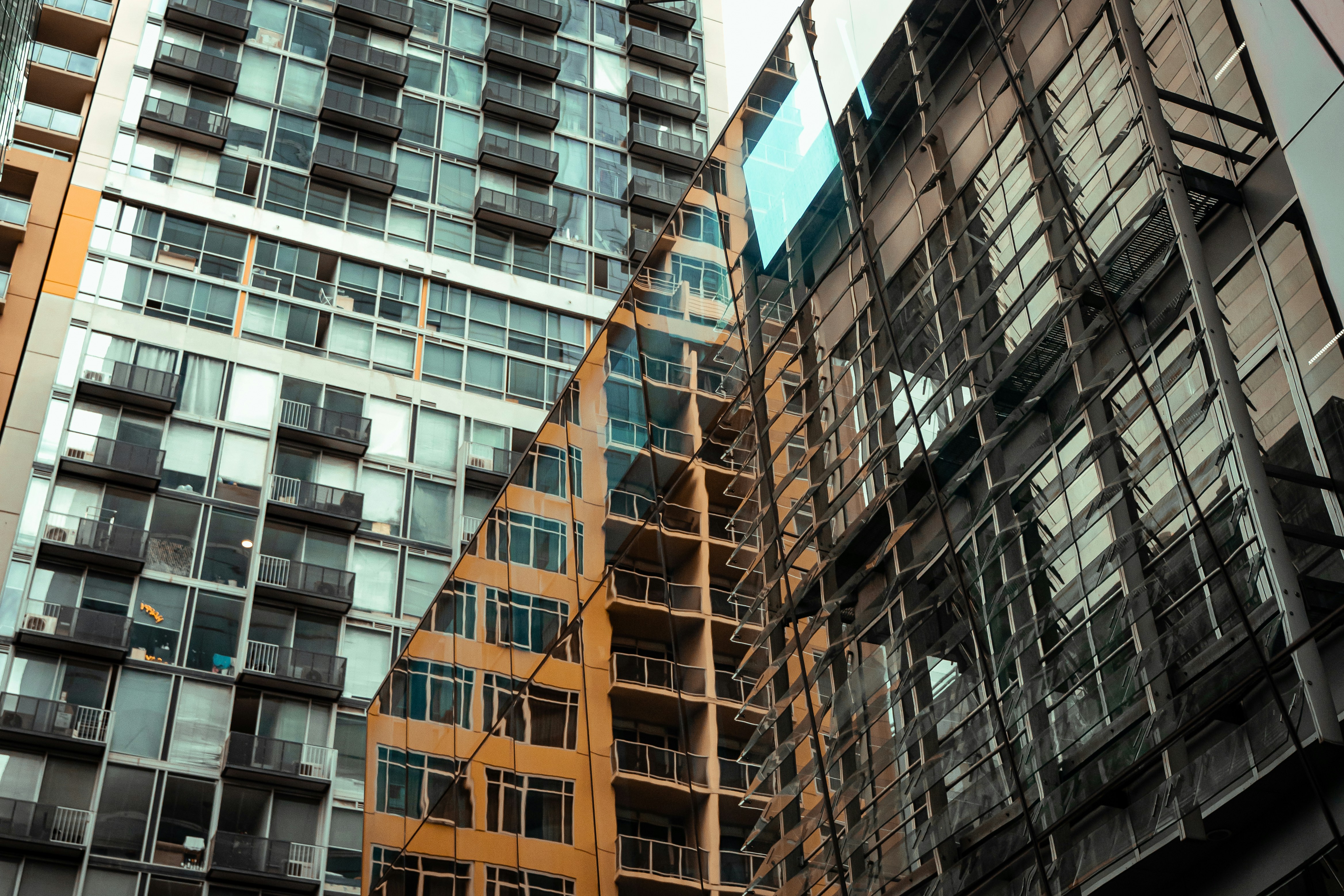 A couple of tall buildings next to each other photo – Free Archietcture ...