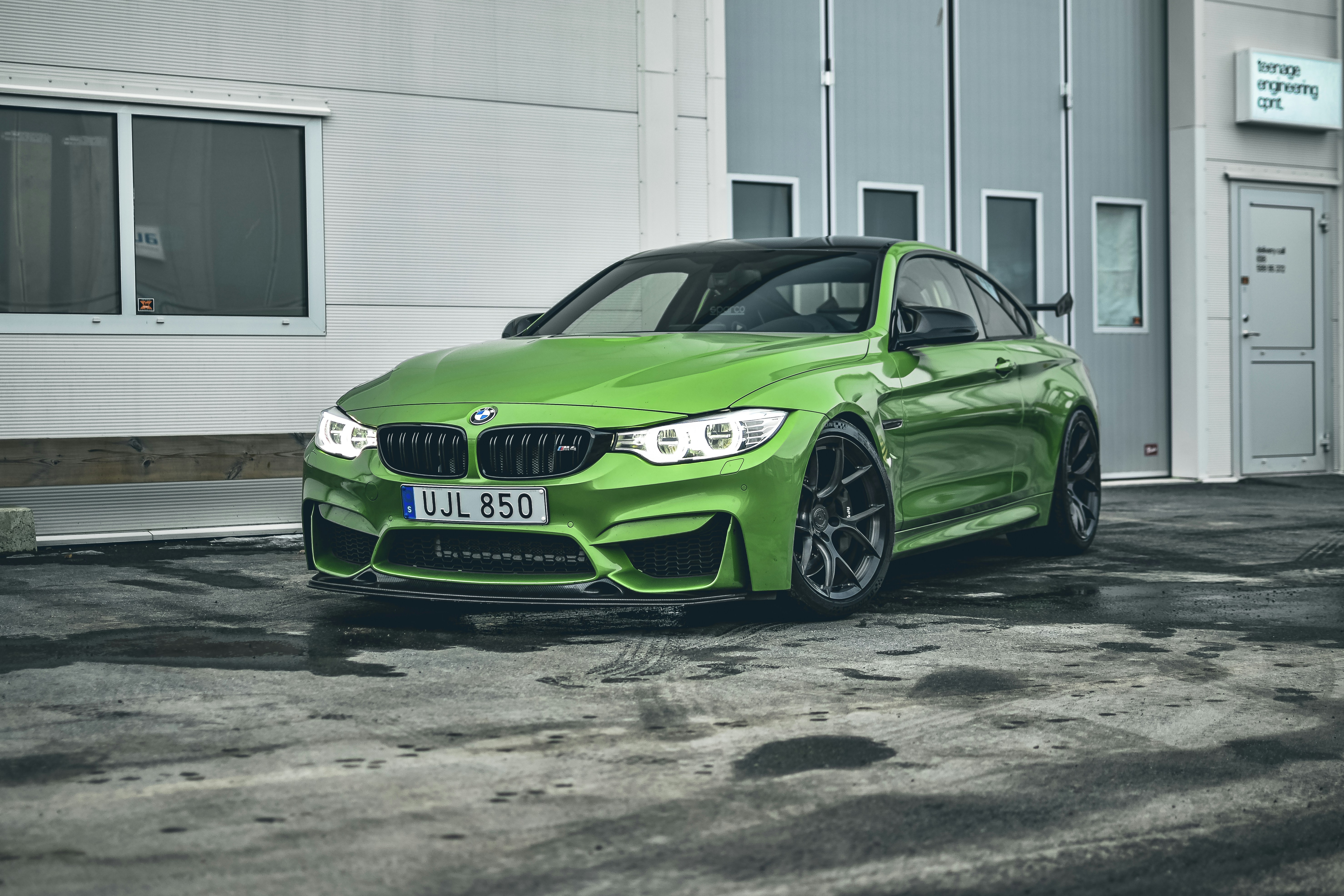 A green car parked in front of a building photo – Free Bumper Image on ...