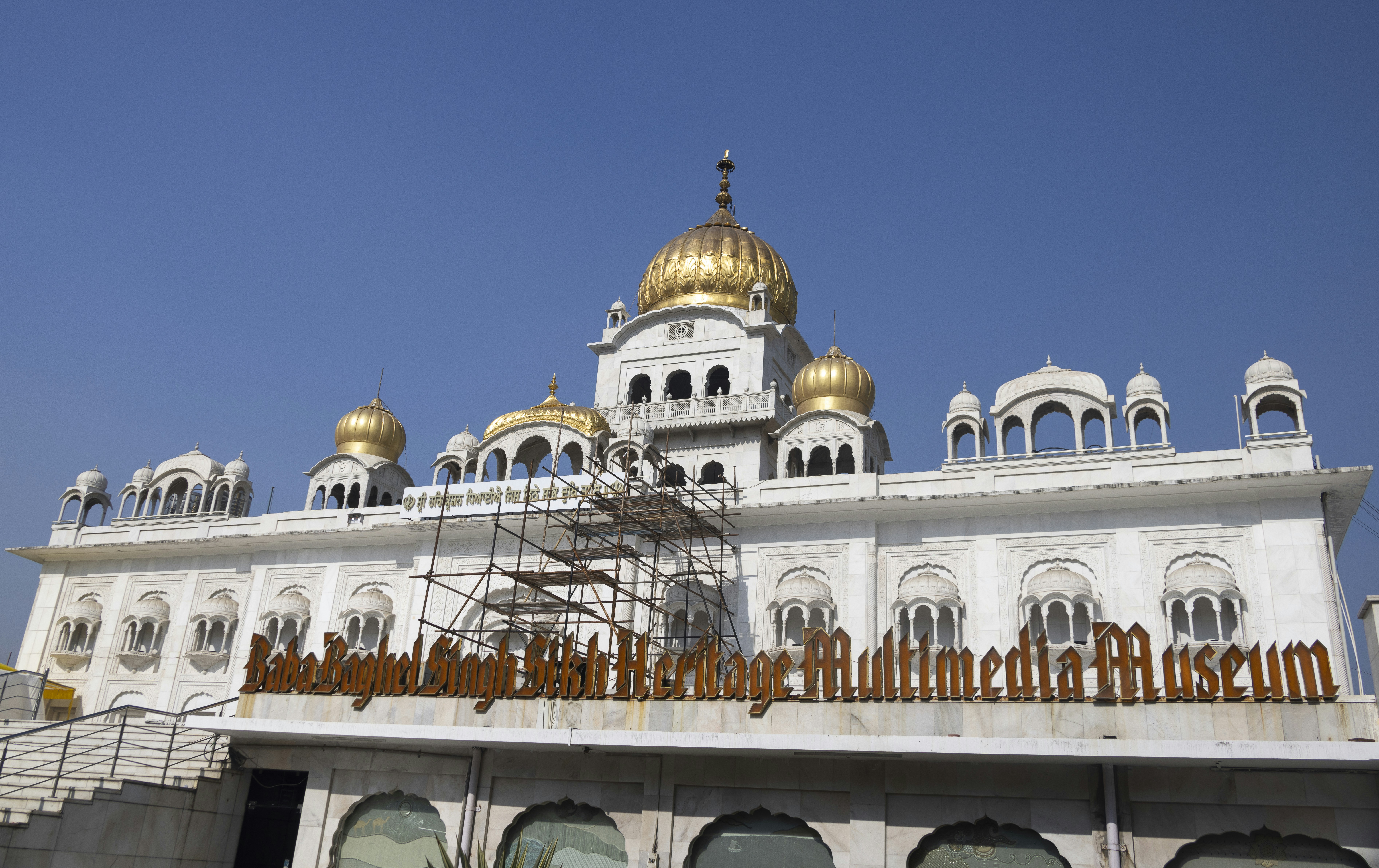 A large white building with gold domes and scaffolding photo – Free ...