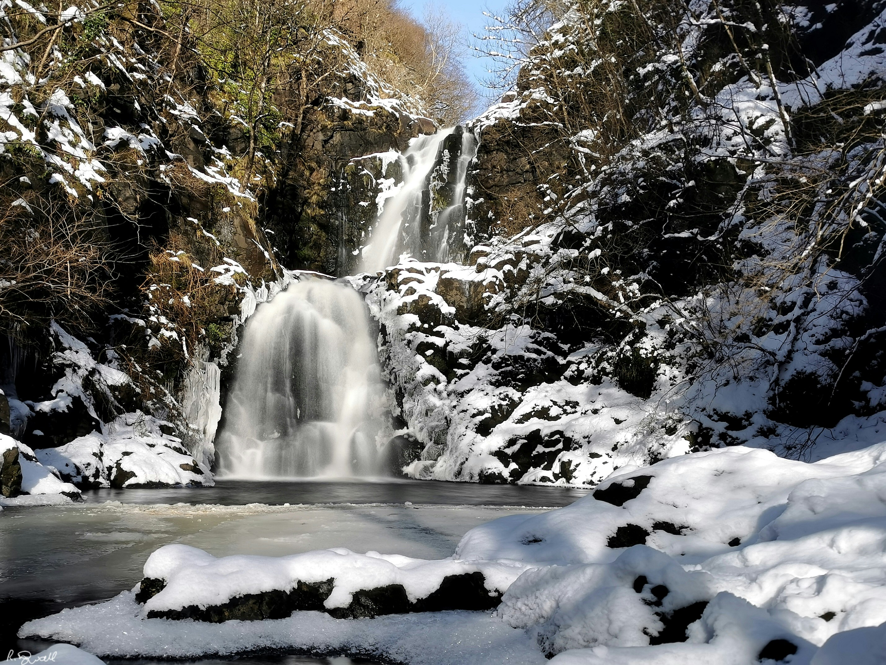Ivory Falls in a Snowbound Gorge Under Winter Light