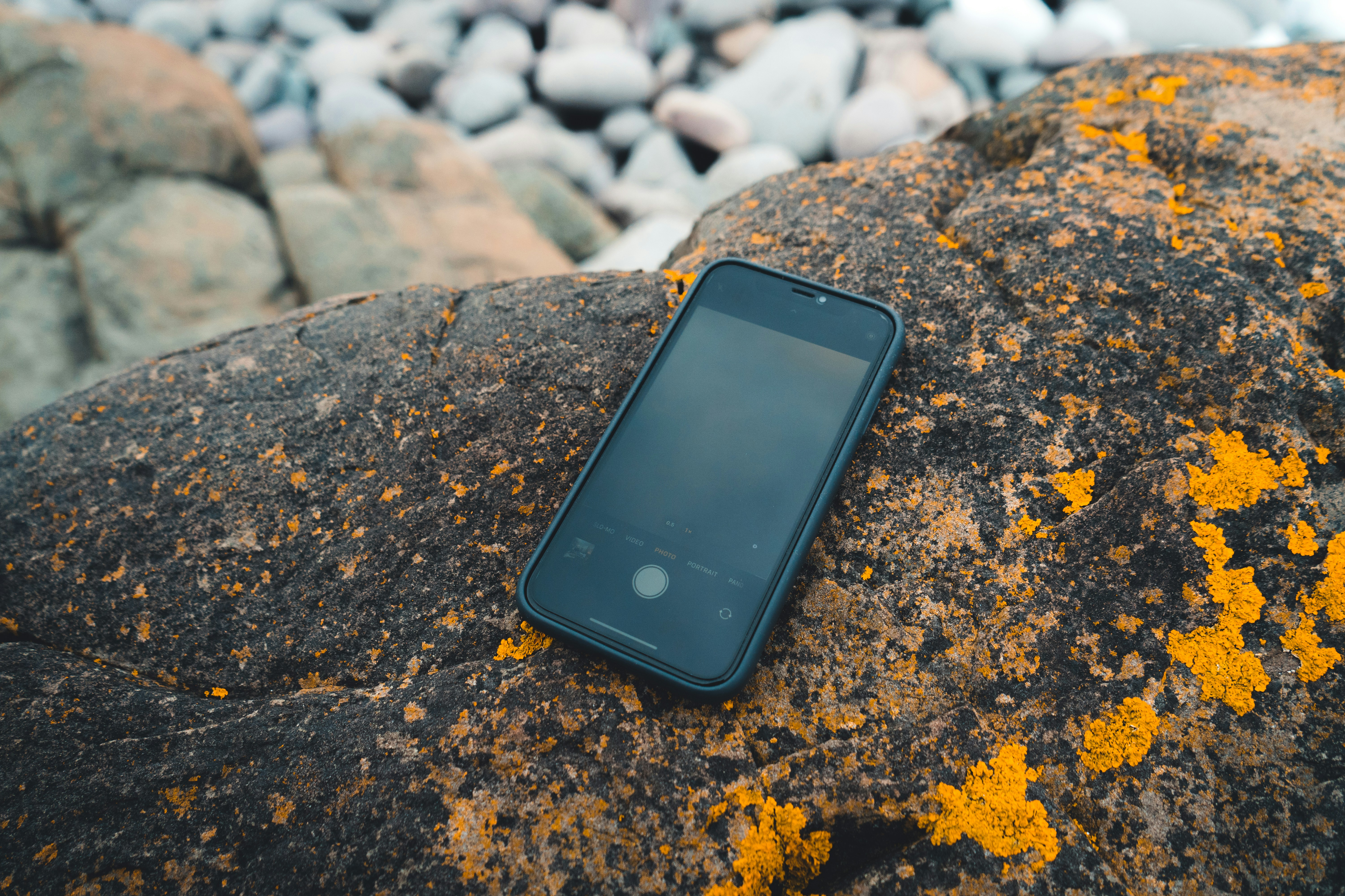 a cell phone sitting on top of a rock