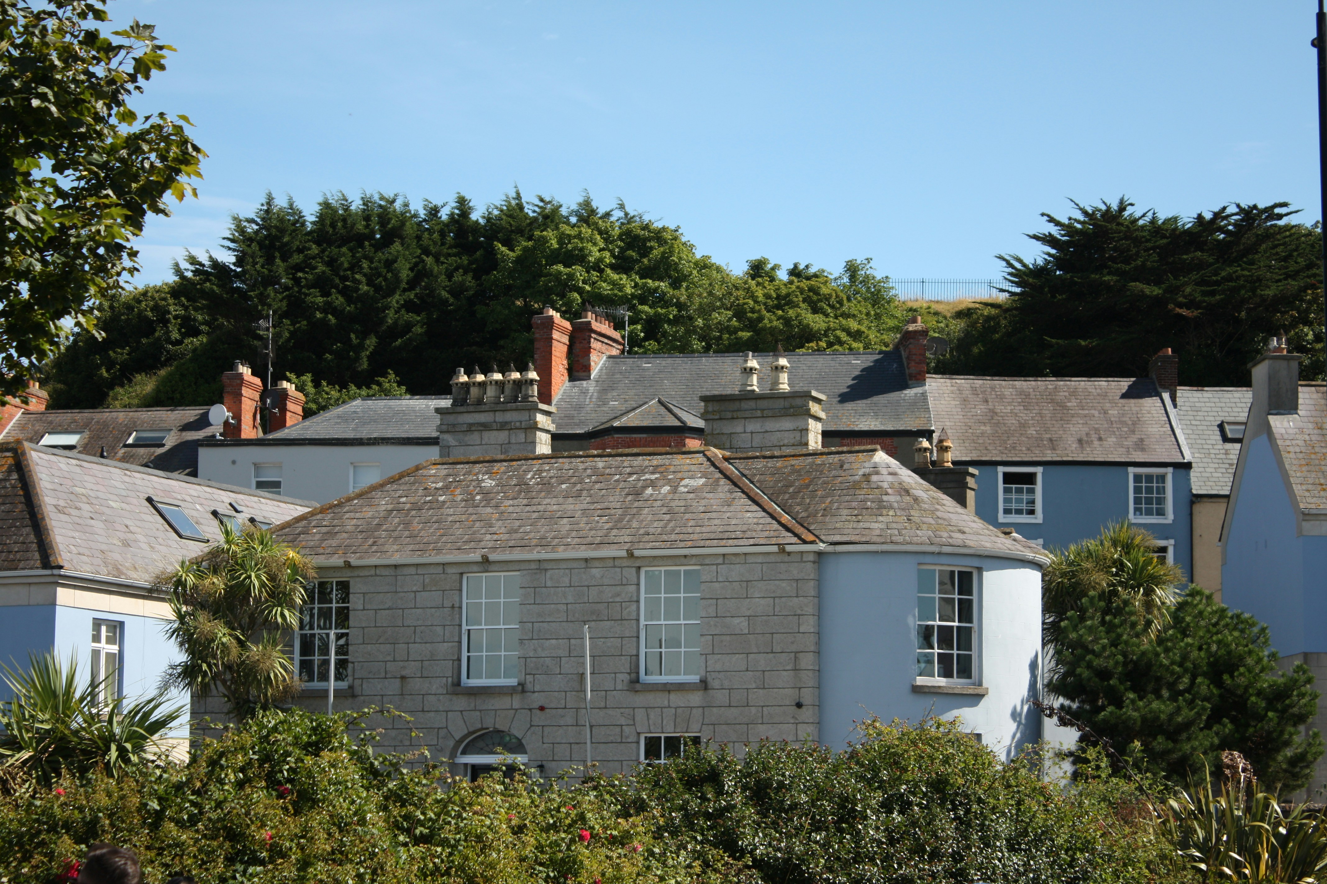 A row of houses with trees in the background photo – Free Howth Image ...