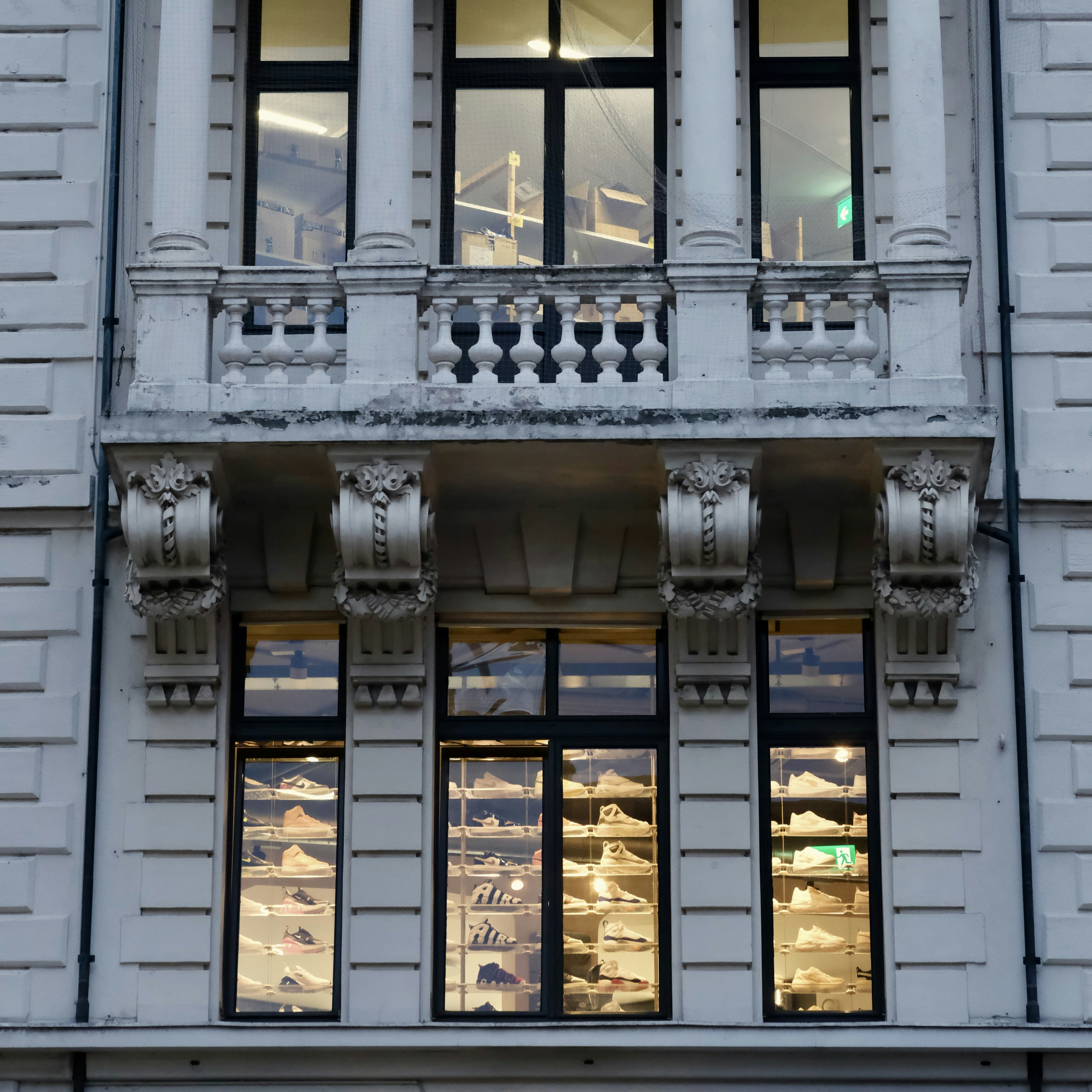Ornate Streetfront Windows Reflect a Courtyard Workshop