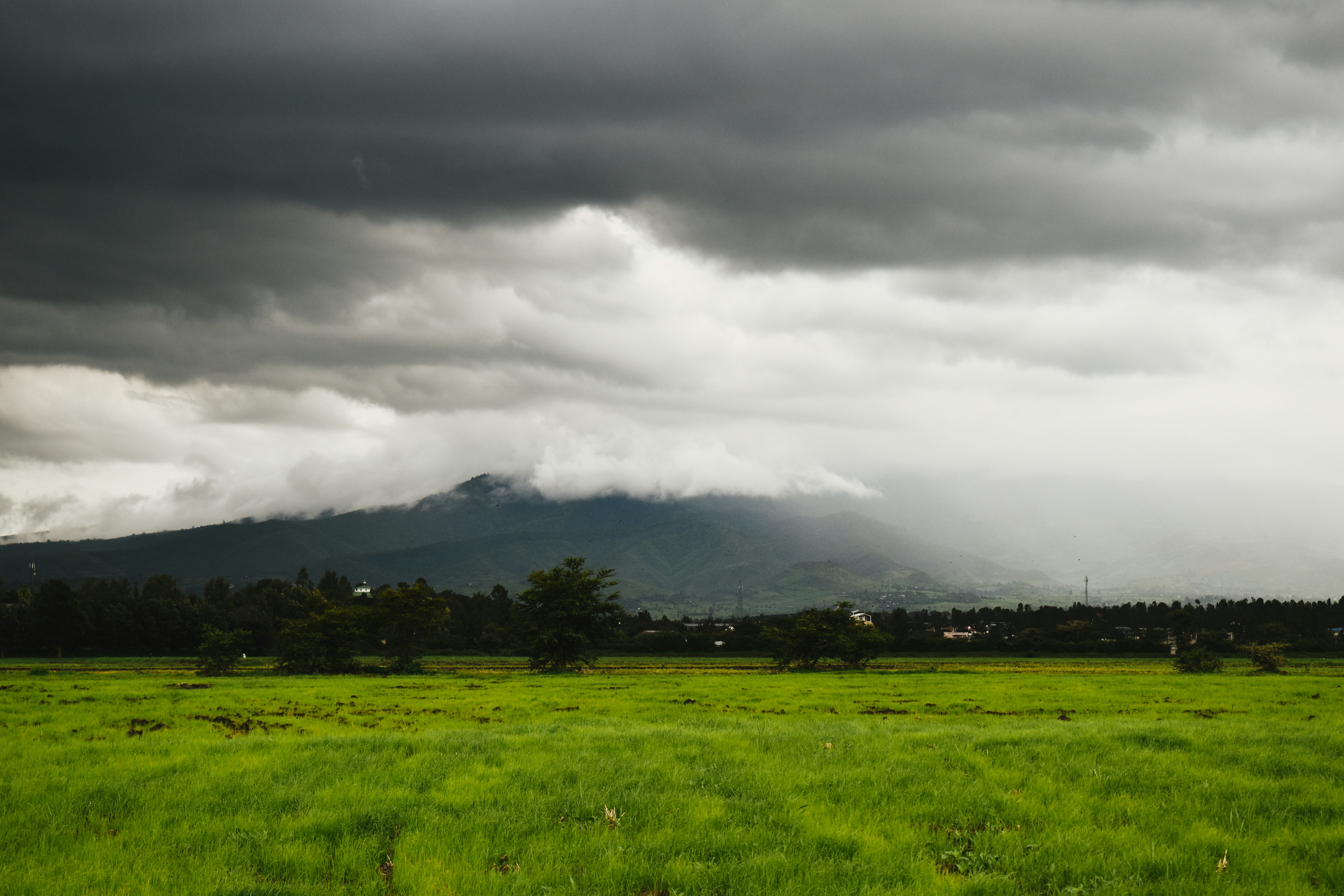 A green field with a mountain in the background photo – Free Yerer ...