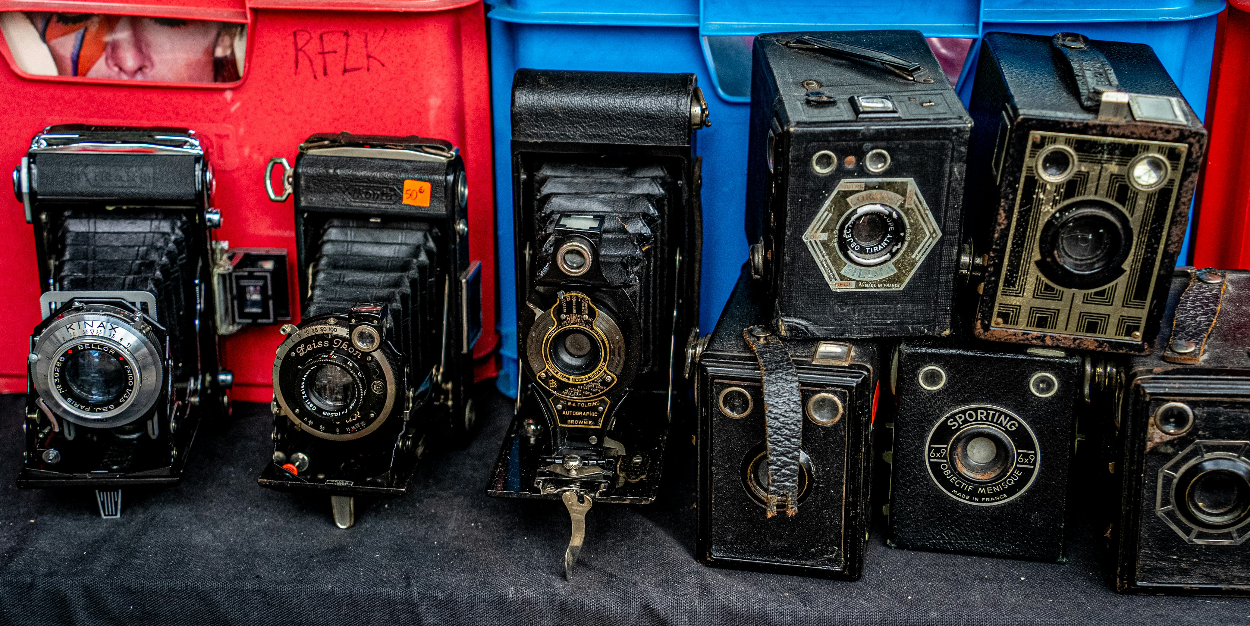 Dusty Legacy: Row of Vintage Cameras Ready for a Portrait
