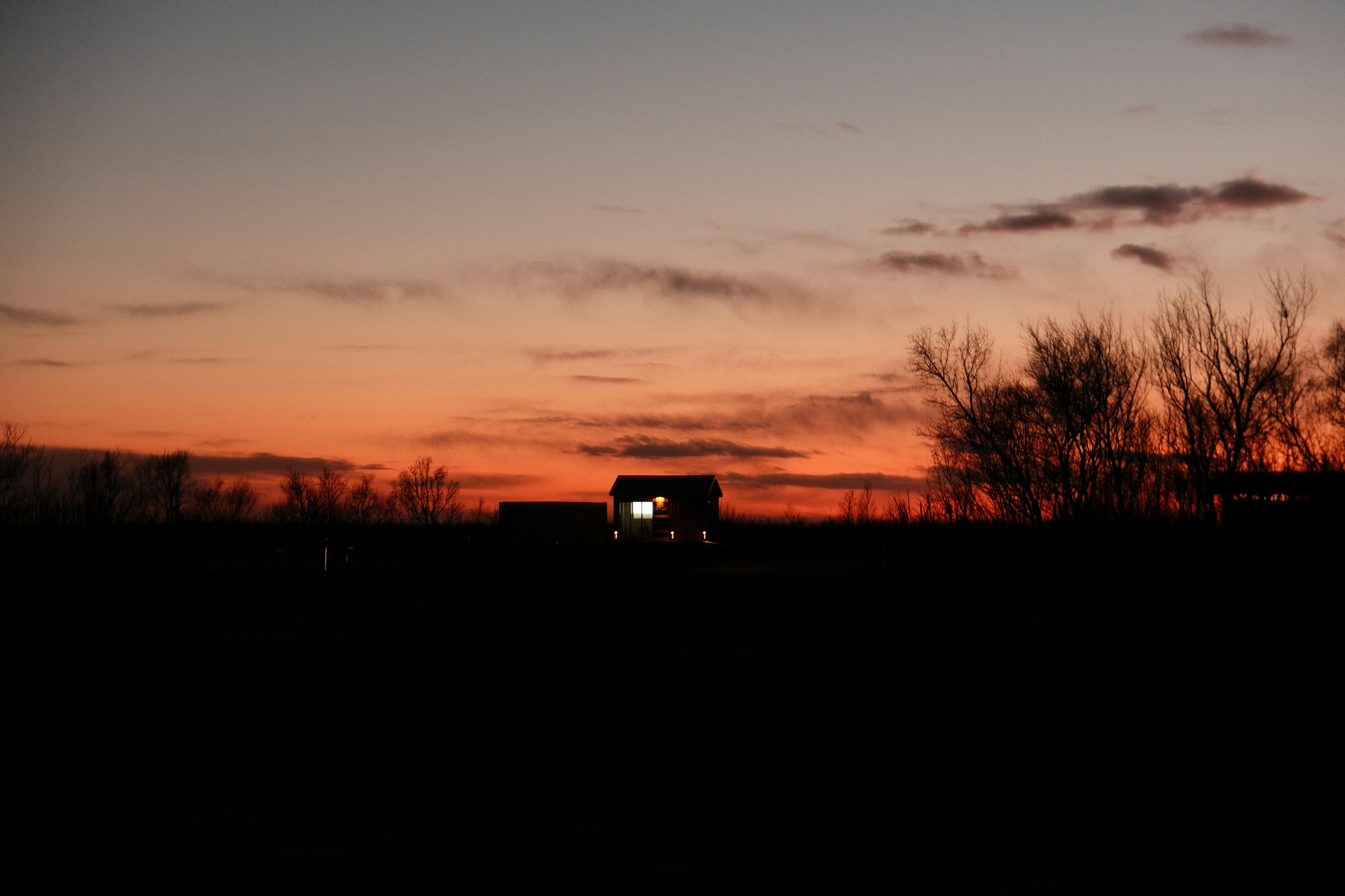 Silhouette at Dusk: A Lone House against a Touched Sky