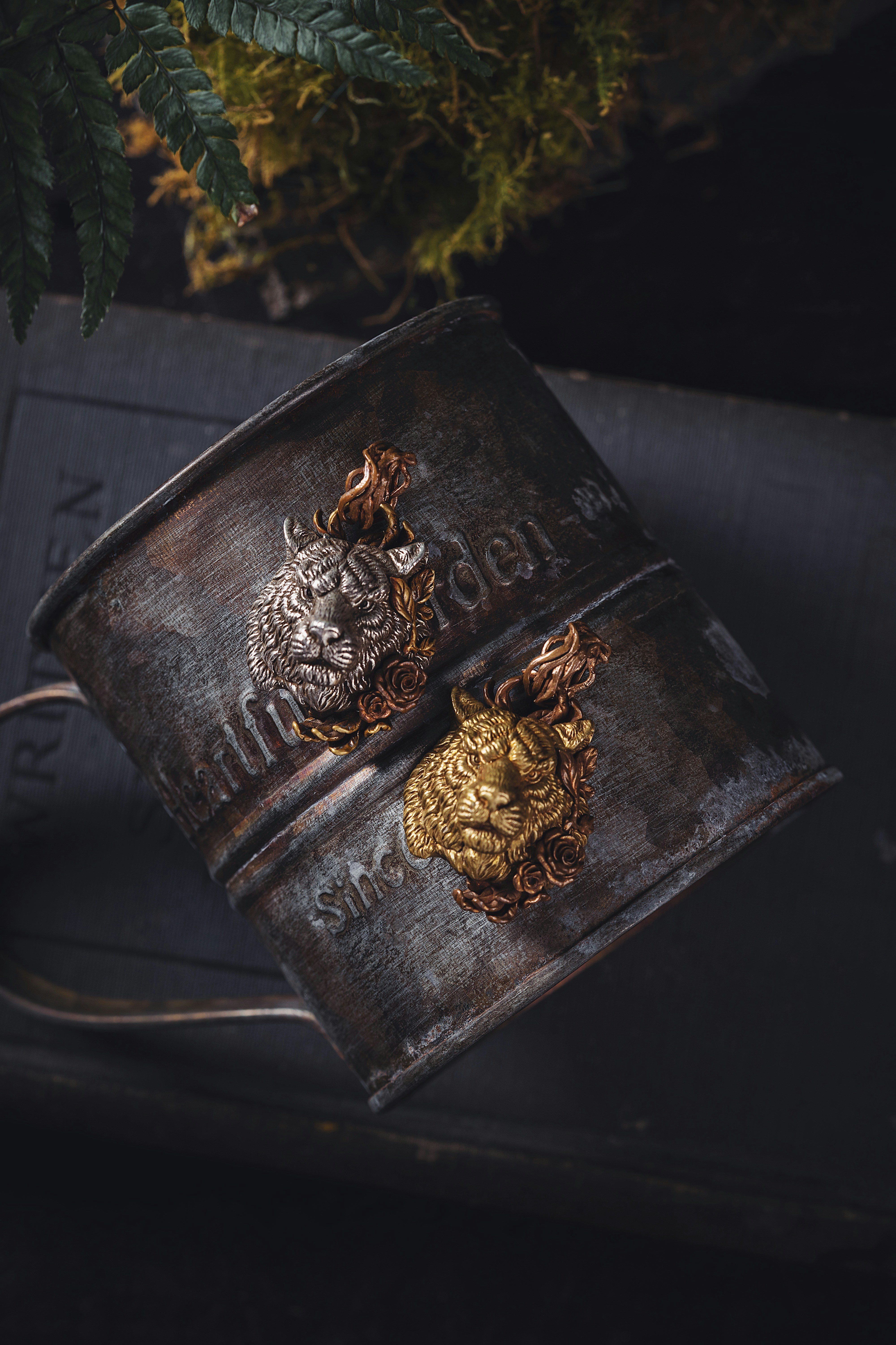 A pair of metal mugs sitting on top of a table photo – Free Wallet ...