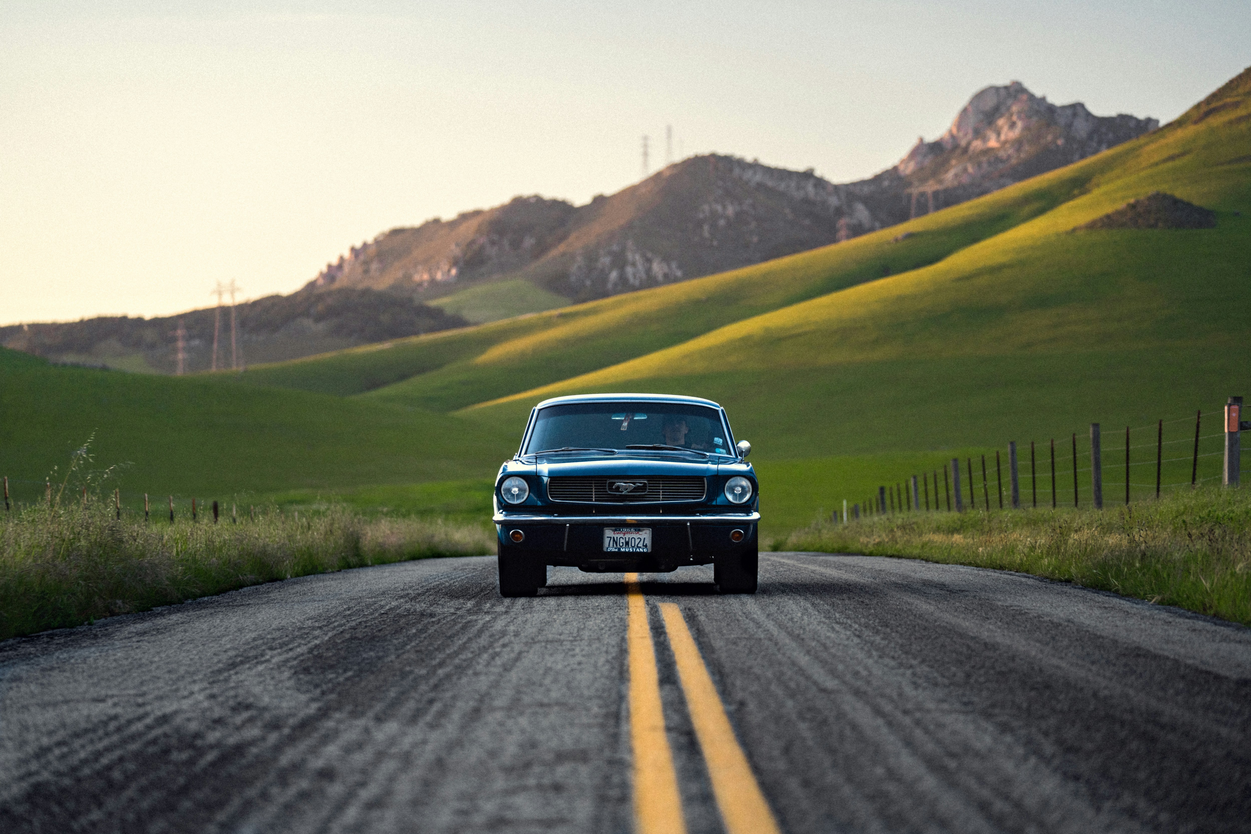 A classic car driving down a country road photo – Free Raw power Image ...