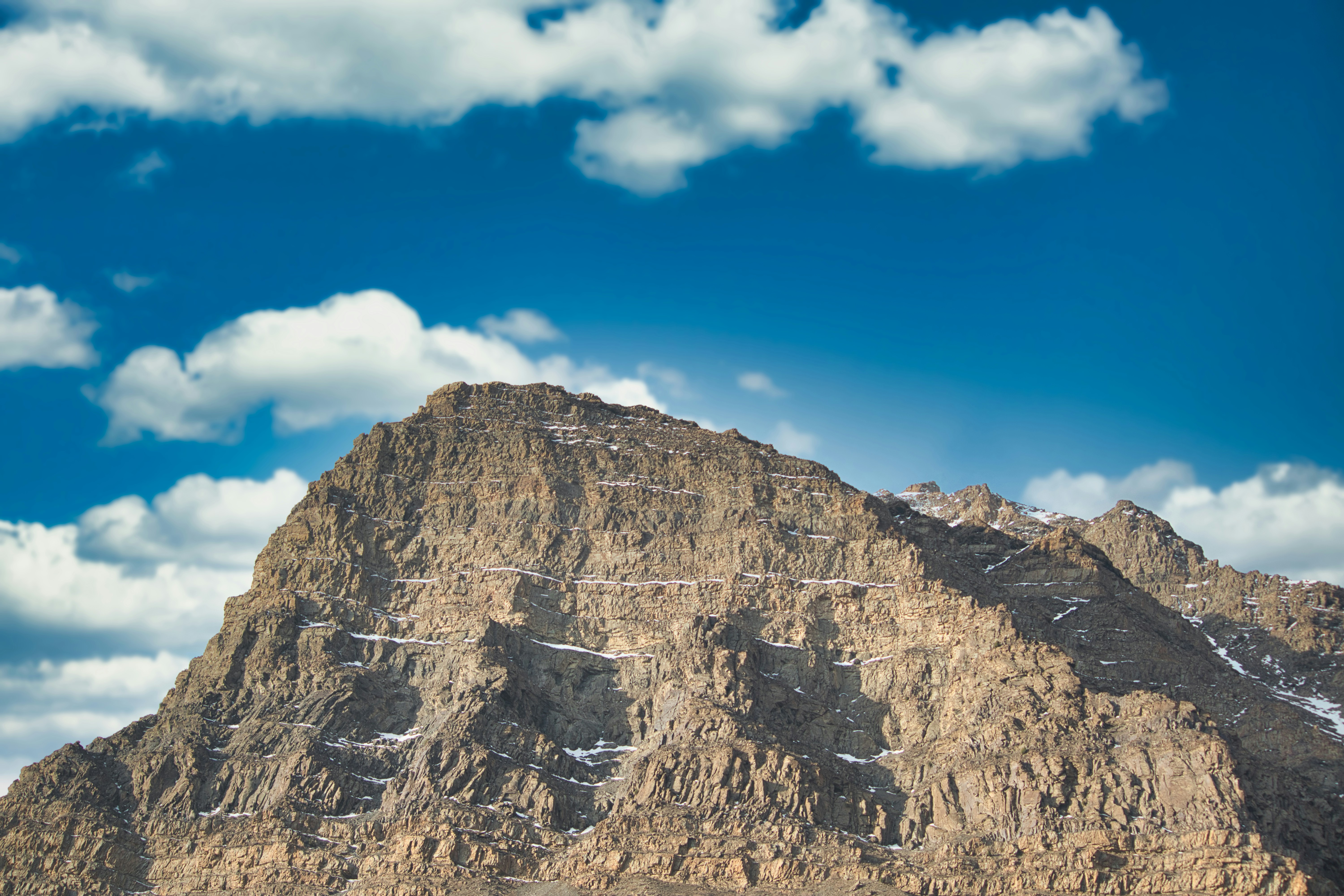 A very tall mountain with a bunch of snow on it photo – Free Peak Image ...
