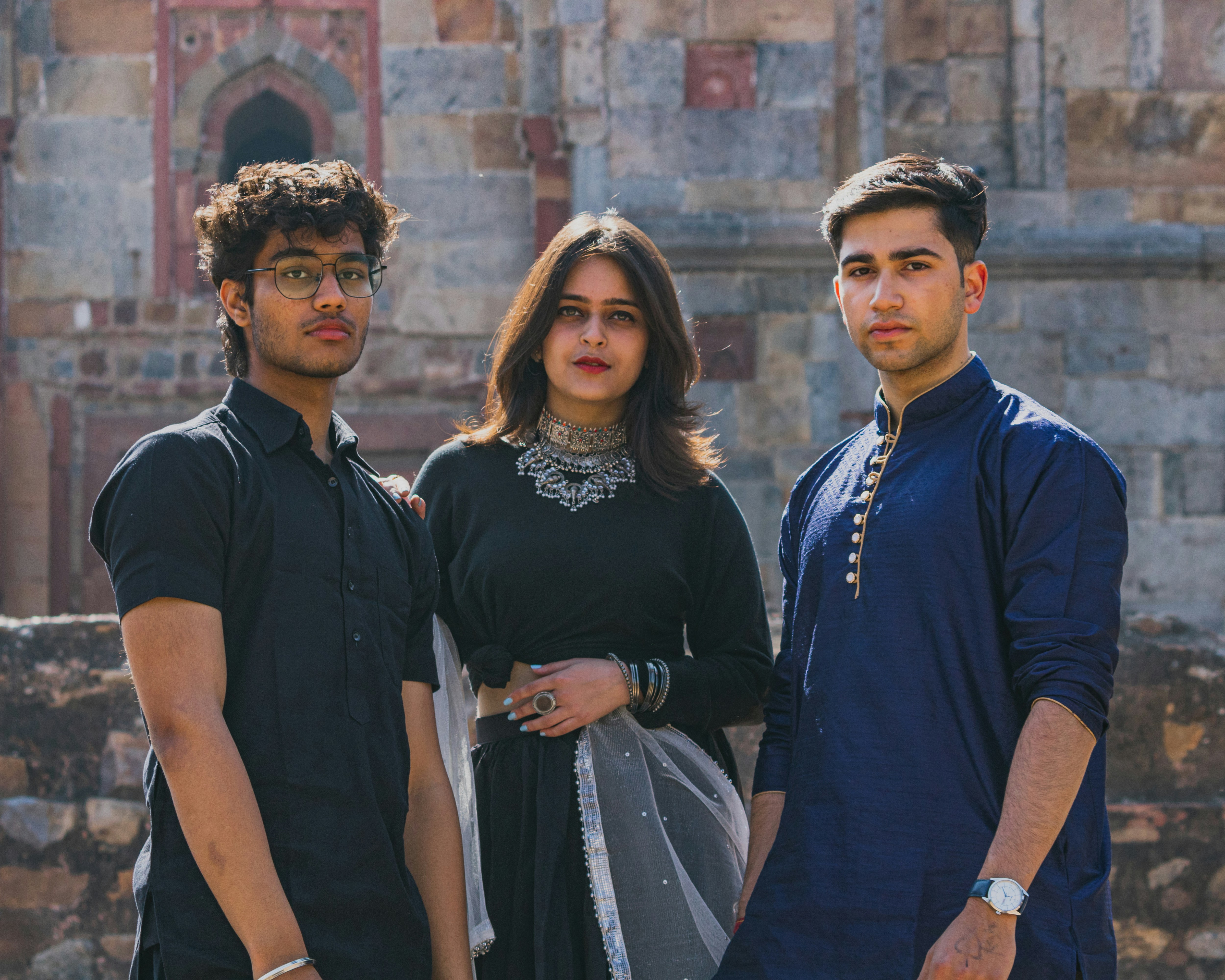 A group of three people standing next to each other photo – Free Person ...