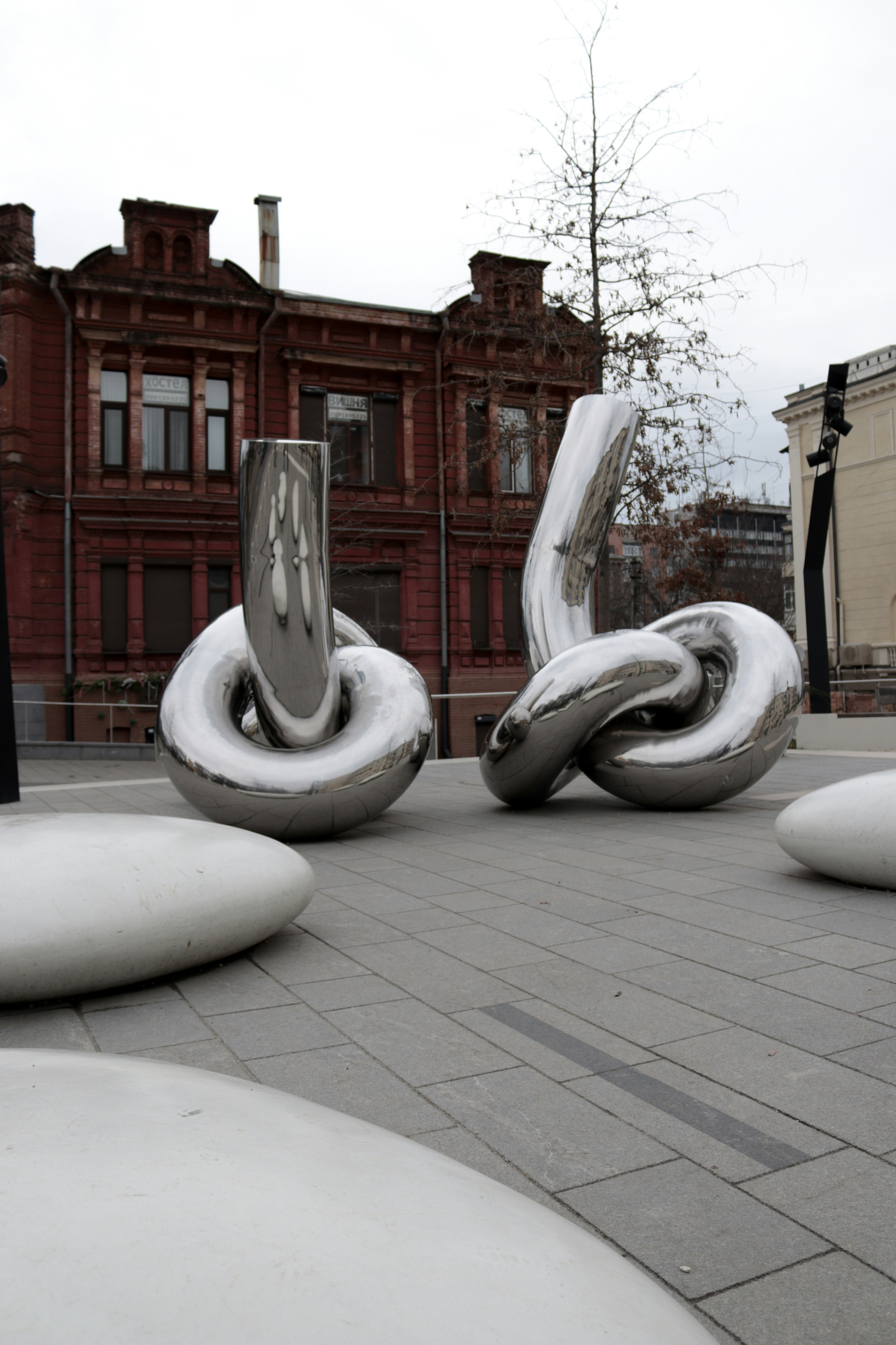 A couple of large metal sculptures sitting on top of a sidewalk photo ...