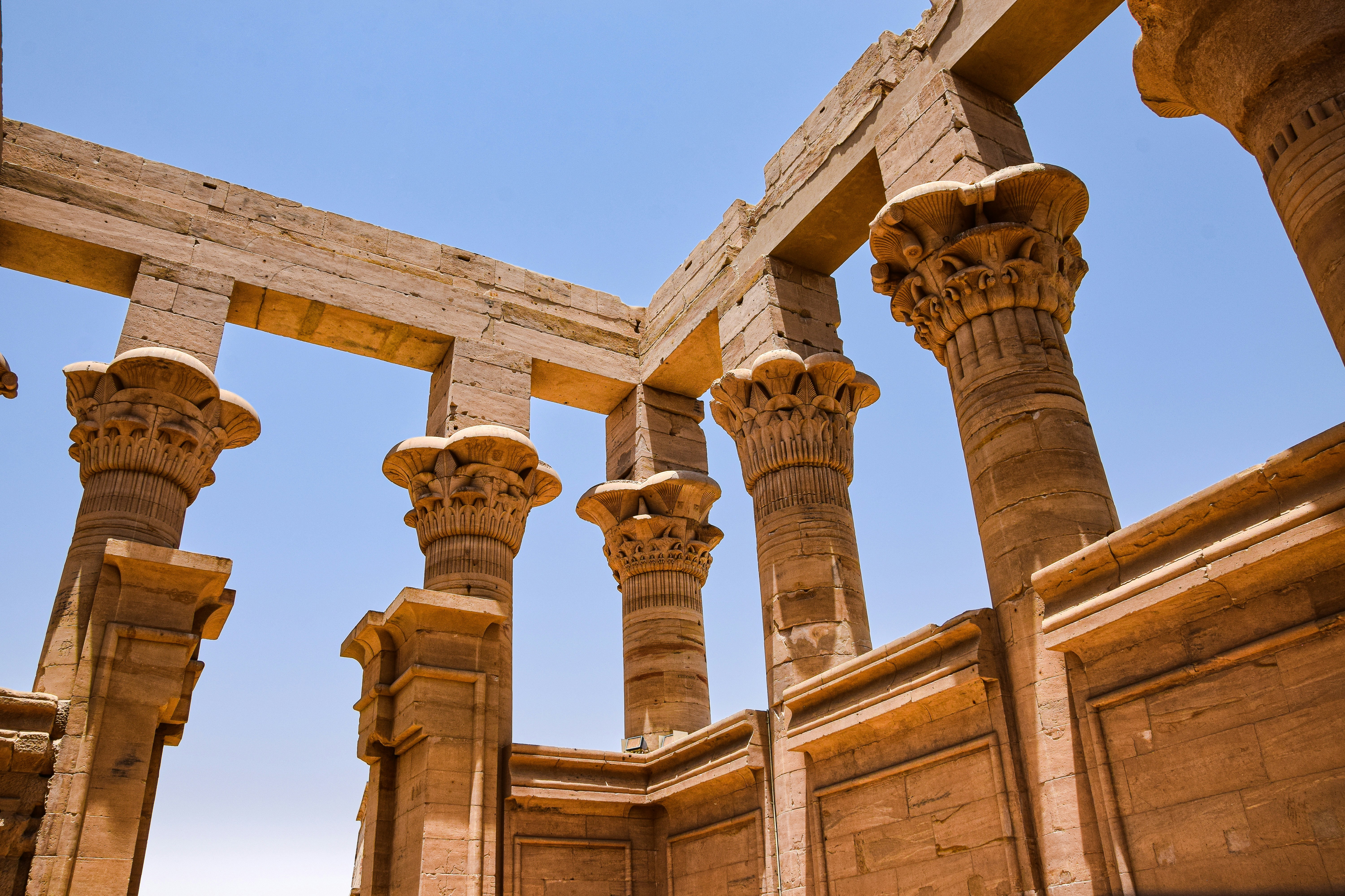 A group of stone pillars in a building photo – Free Aswan Image on Unsplash