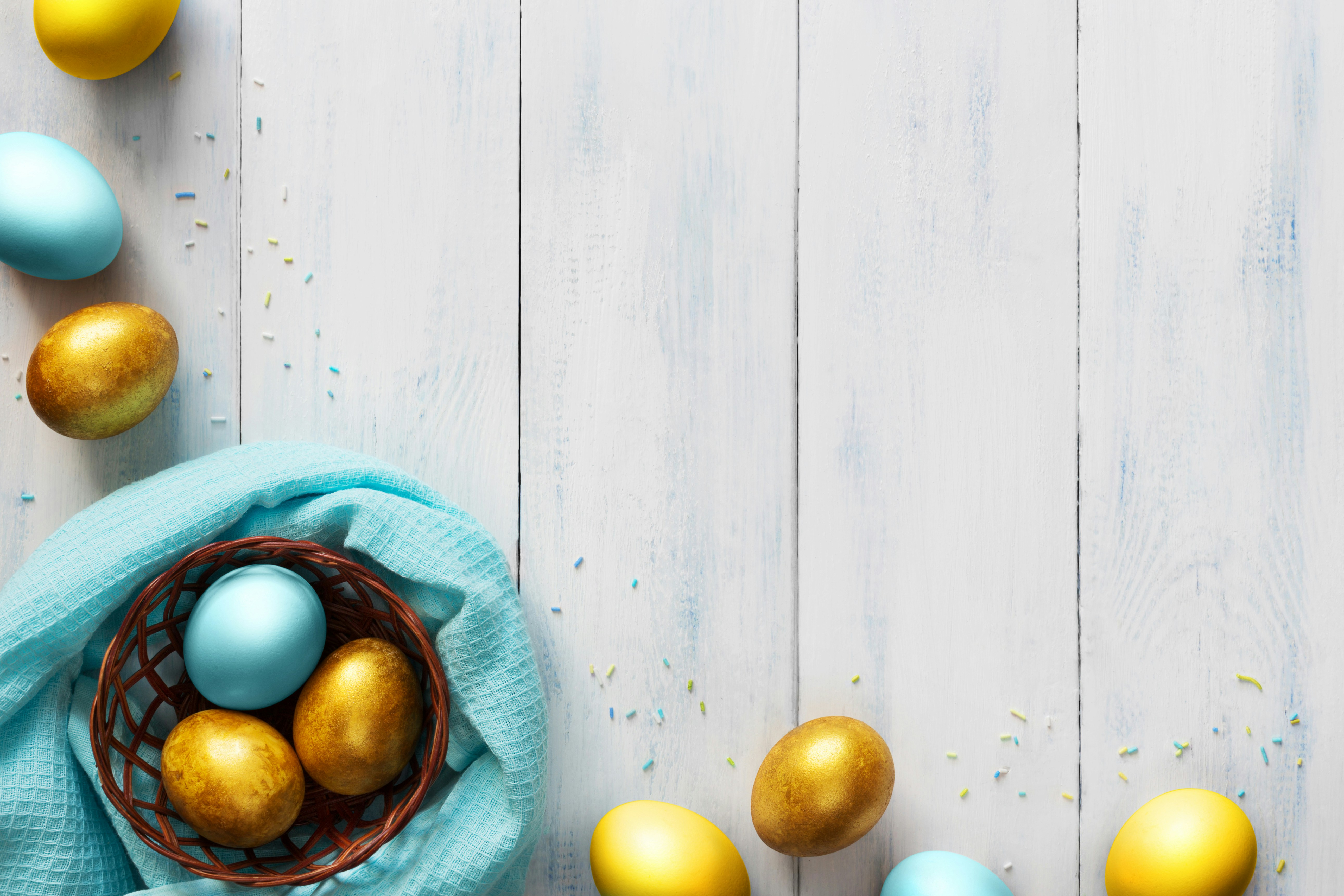 Pastel Easter Nest: A Tiny Wicker Basket of Eggs on Weathered White Wood