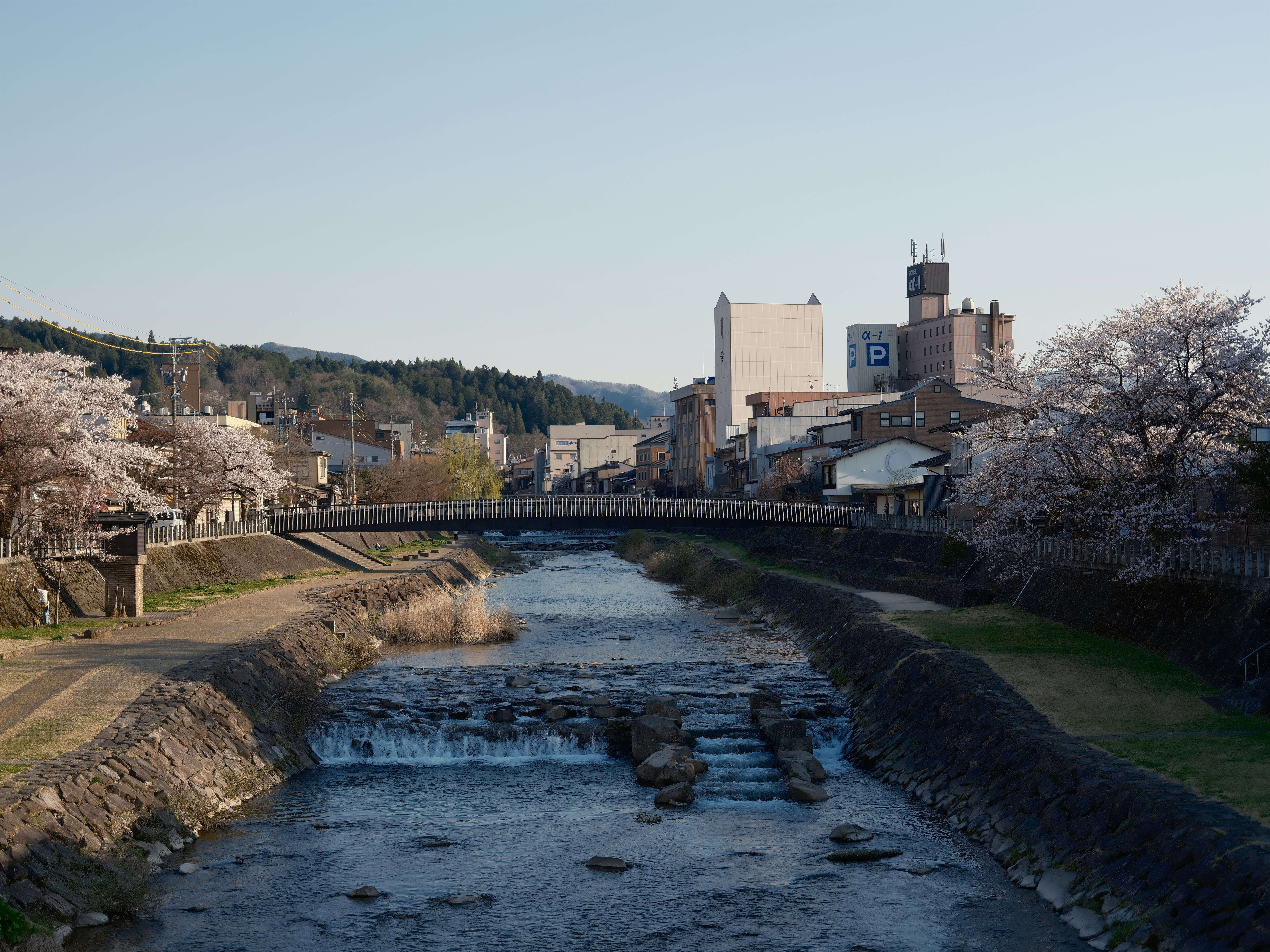 a river running through a city next to tall buildings