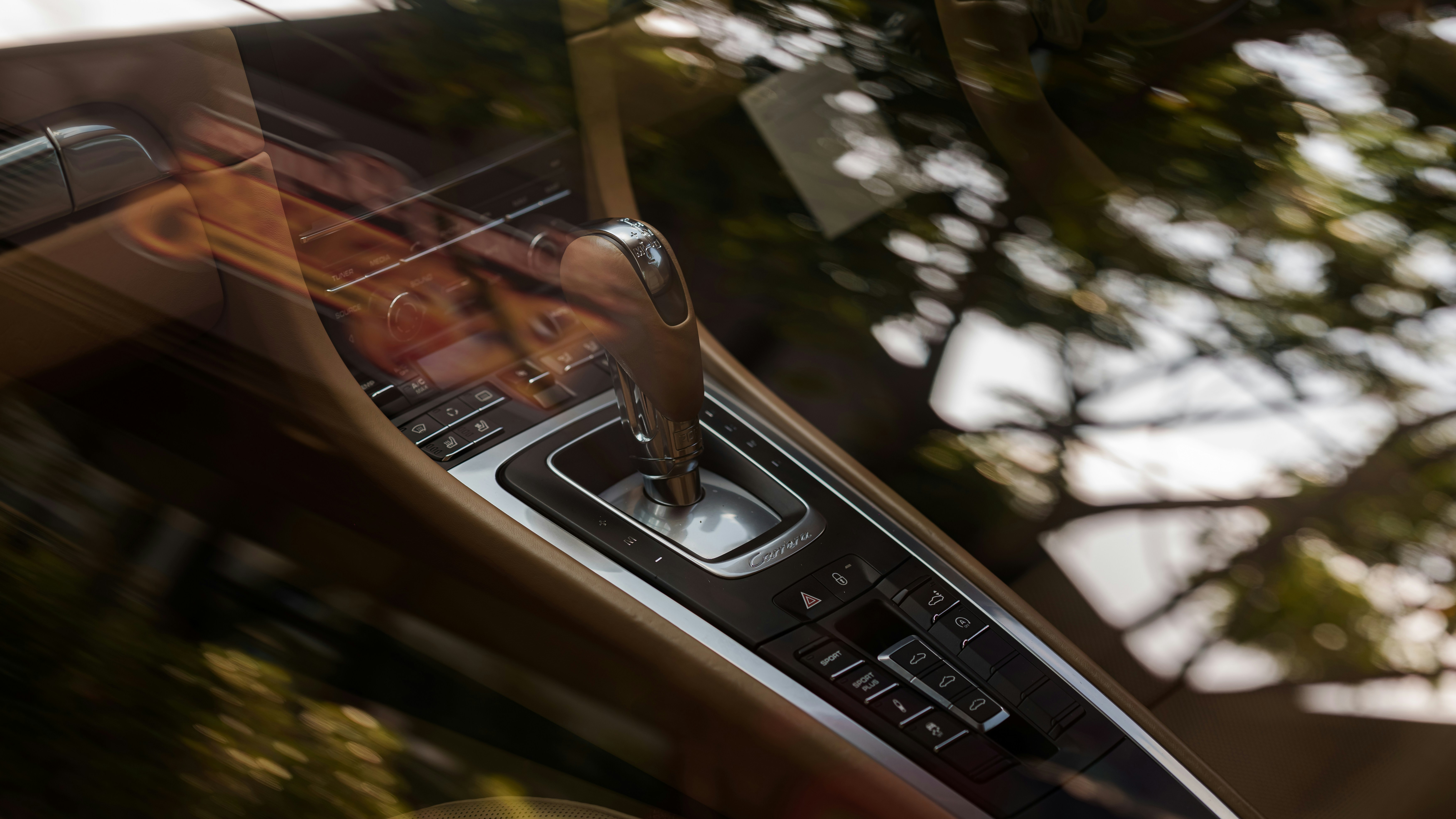 Center-Console in Motion: Leather, Chrome, and Glass Reflections