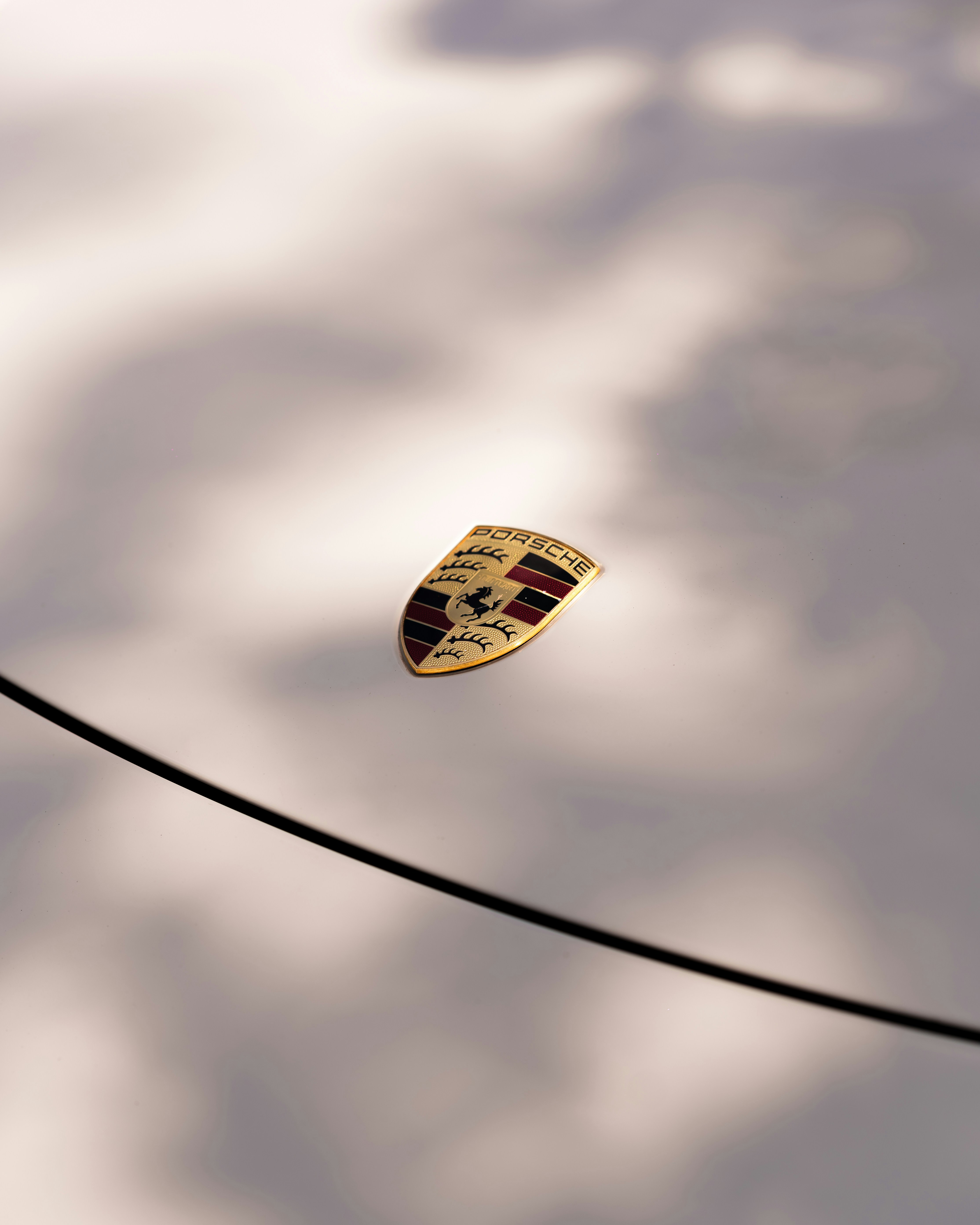Floating Porsche Crest Against a Velvet Sky: Minimalist Close-Up