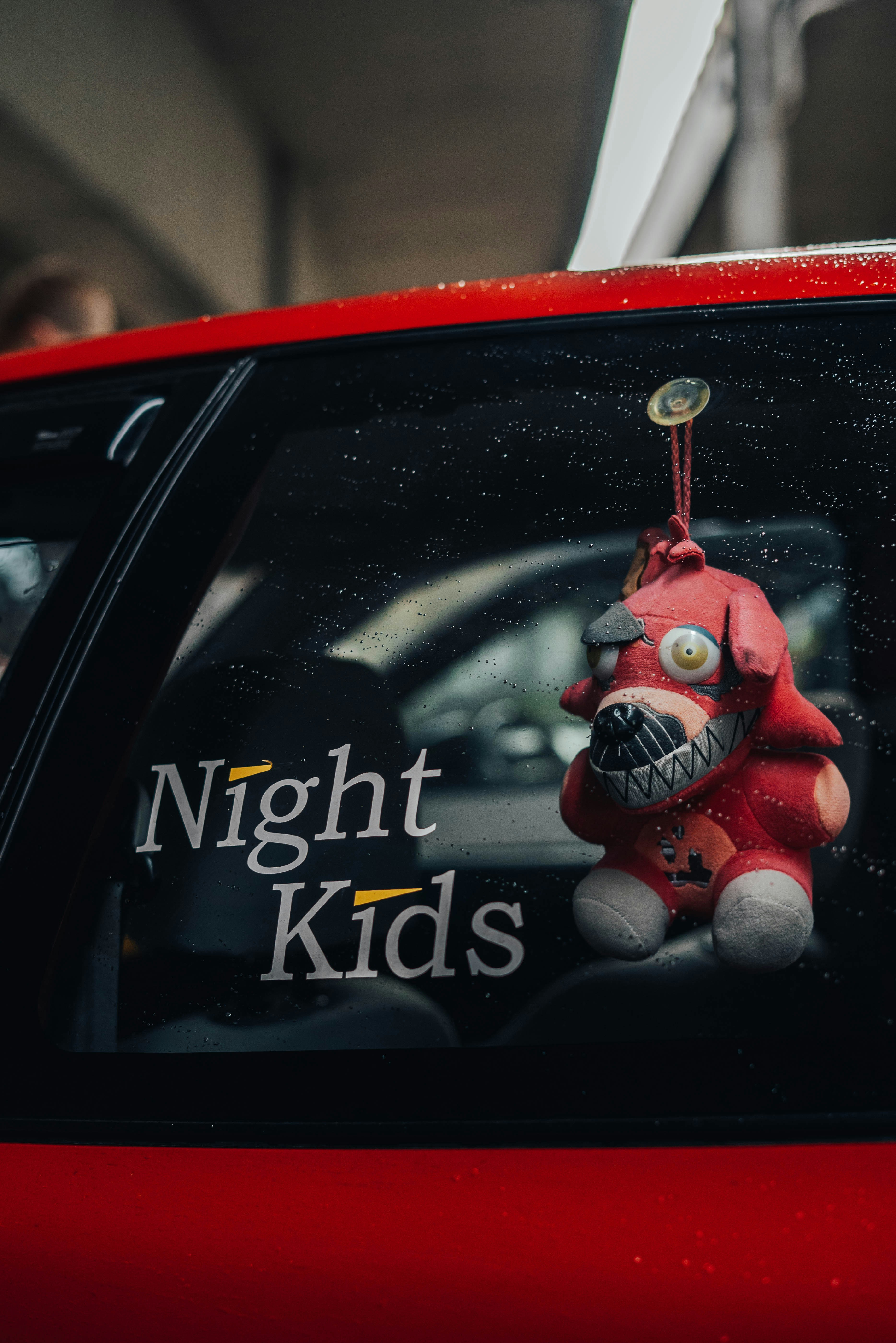 Night Kids: A Plush Guardian in the Car Window
