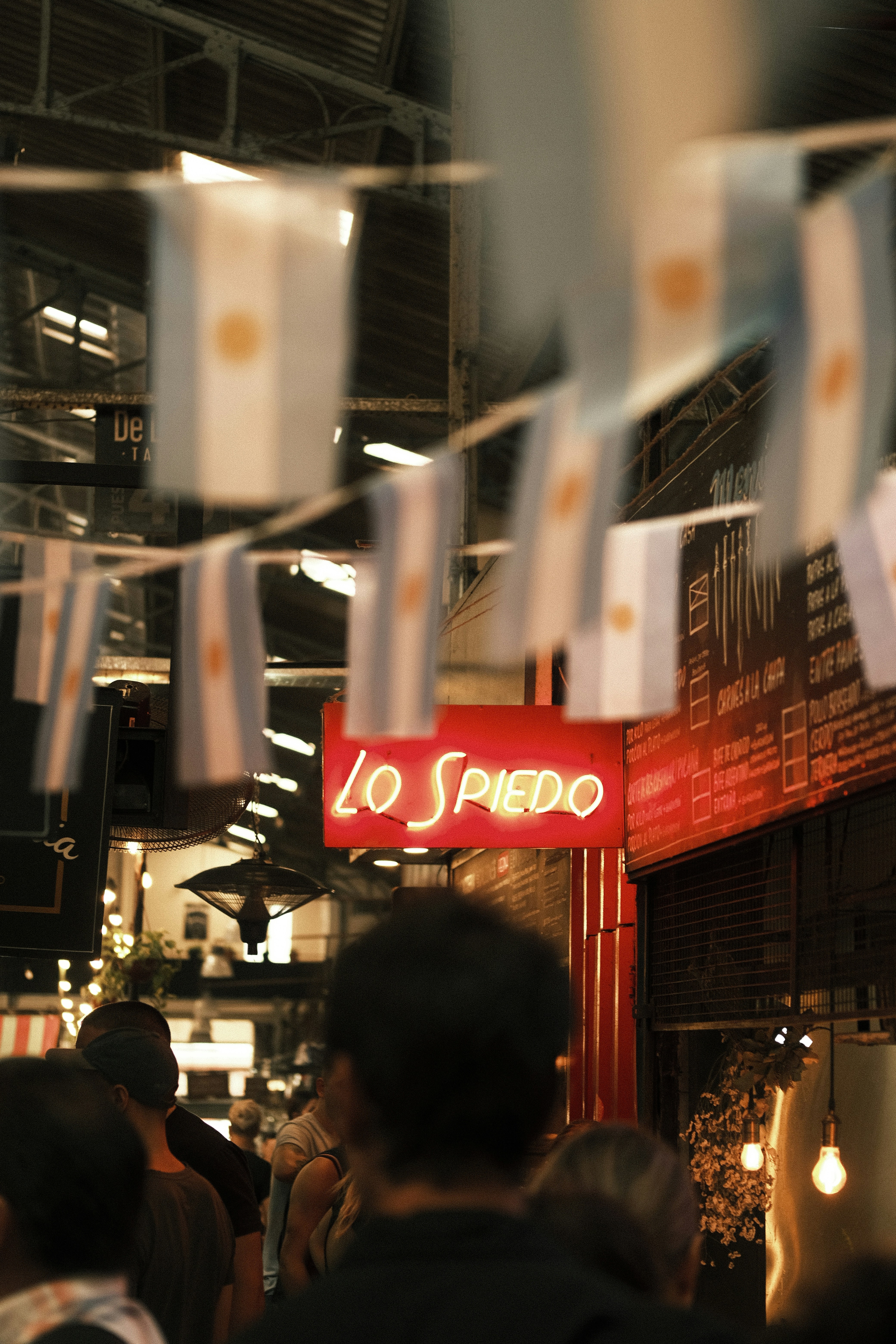 Lo Spiedo Neon: A Crimson Beacon in a Crowded Market Hall