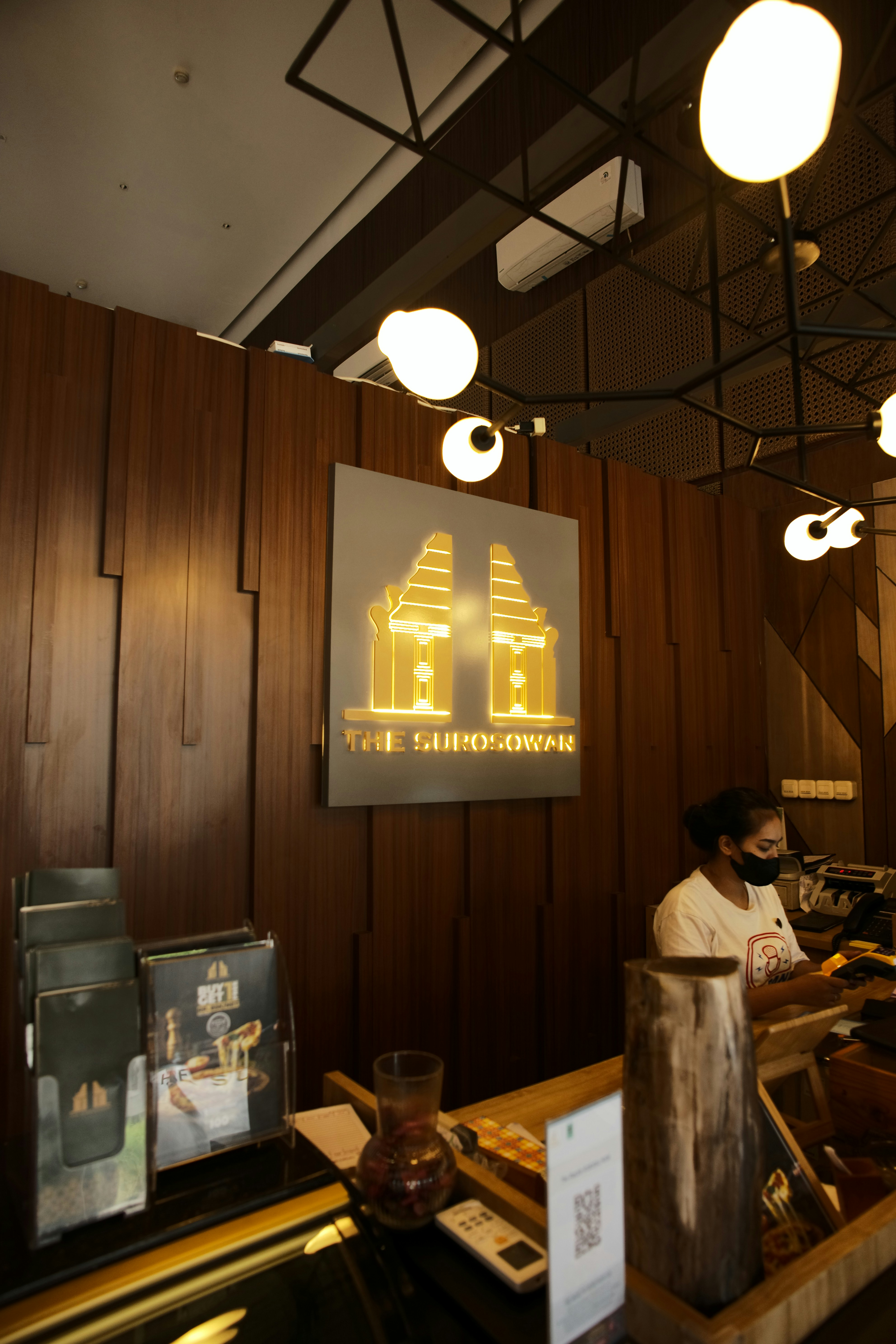 a person sitting at a counter in a restaurant