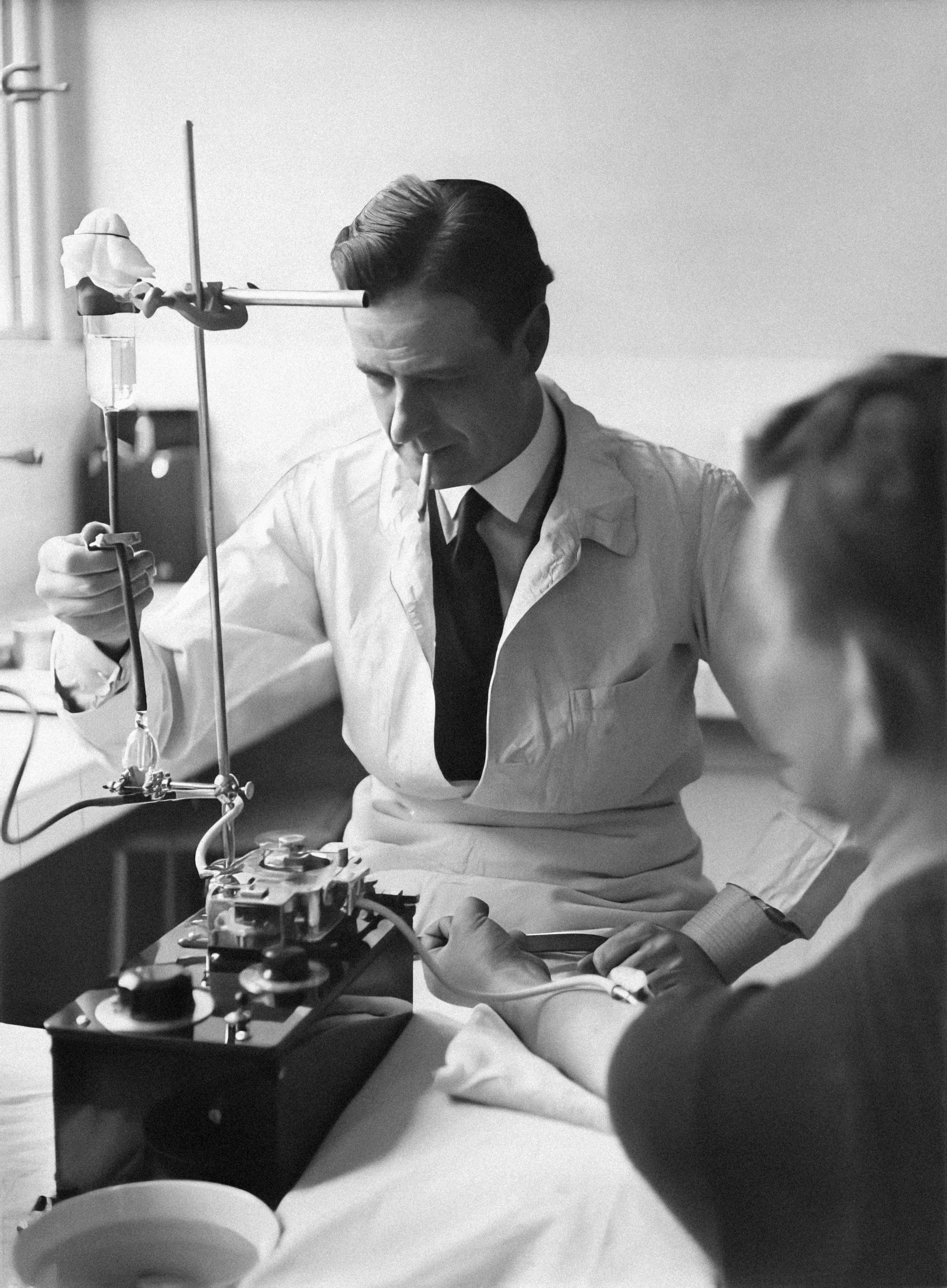 A black and white photo of a man in a doctor's office photo – Free Film ...