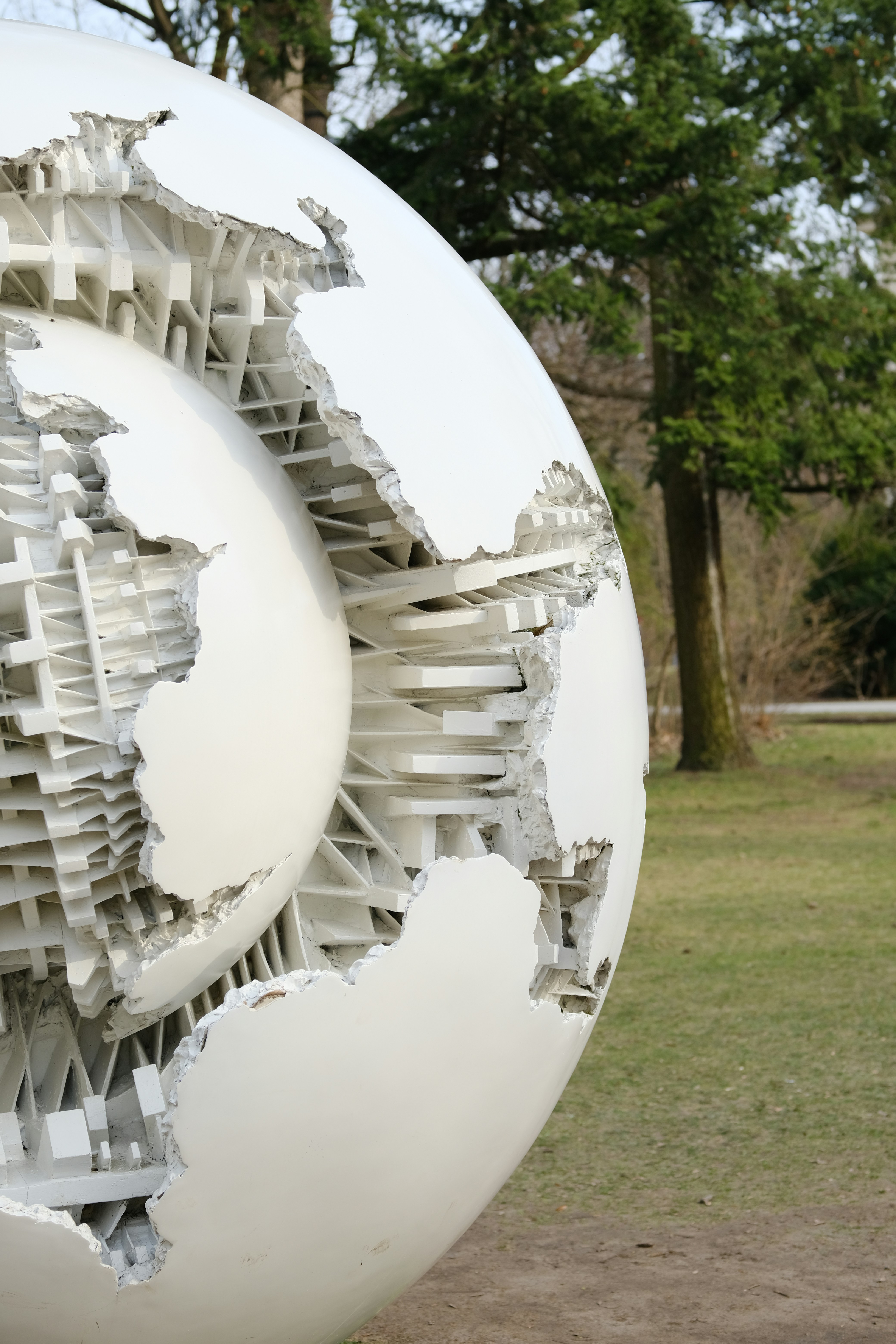 Fragmented Sphere: A Weathered Monument in a Quiet Park
