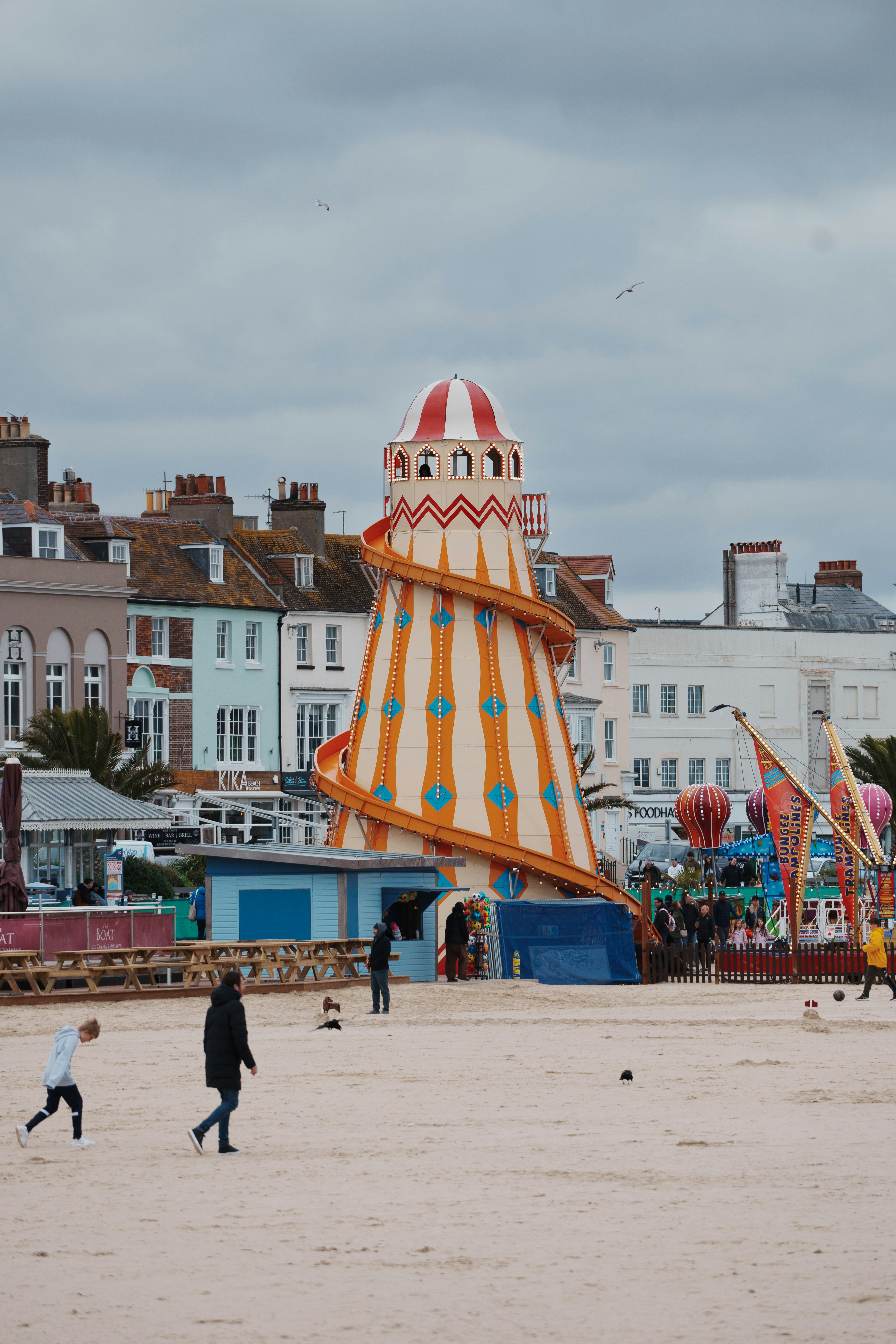 Spiral Carnival Slide Winds Through a Seaside Pastel Landscape