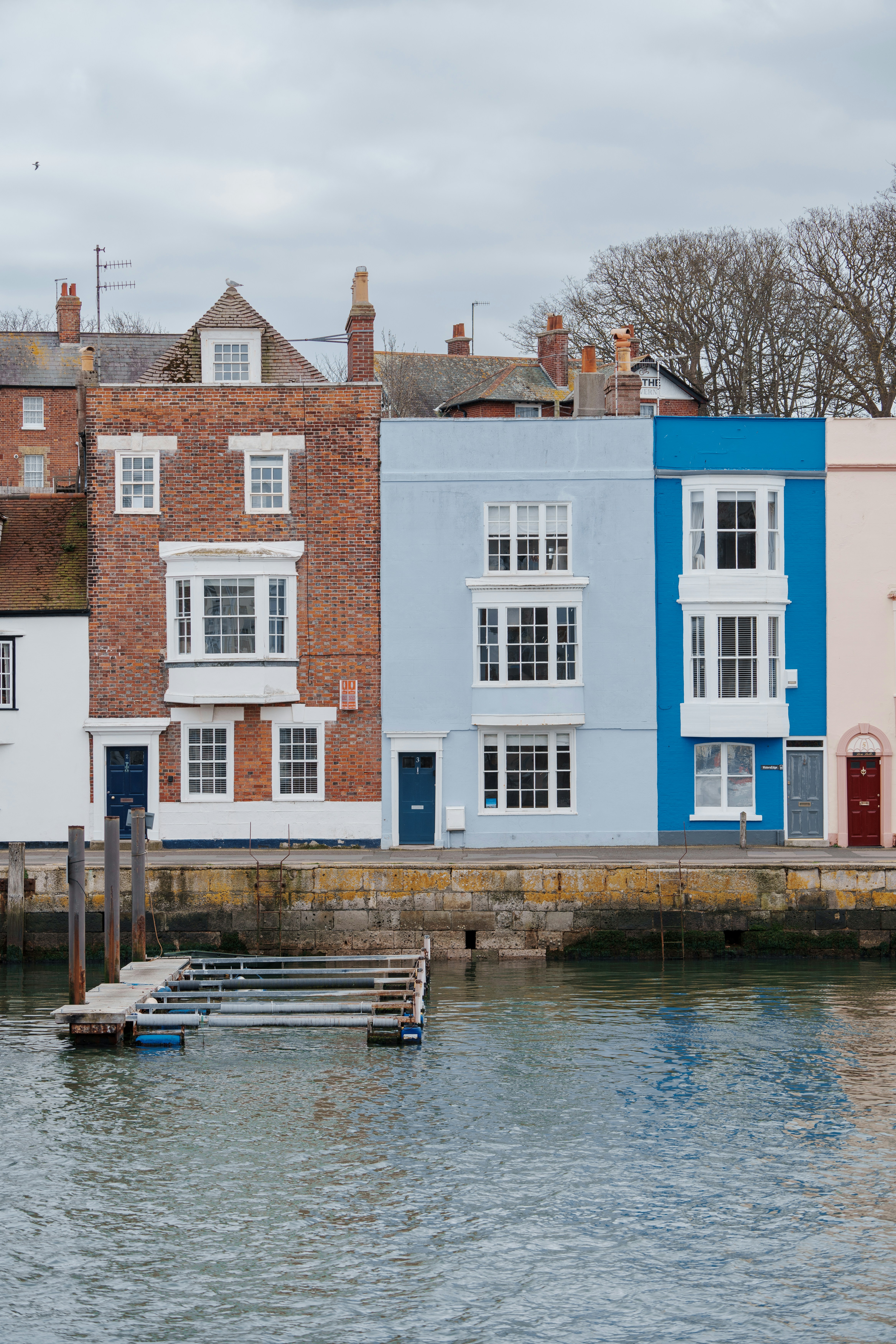 a row of houses next to a body of water