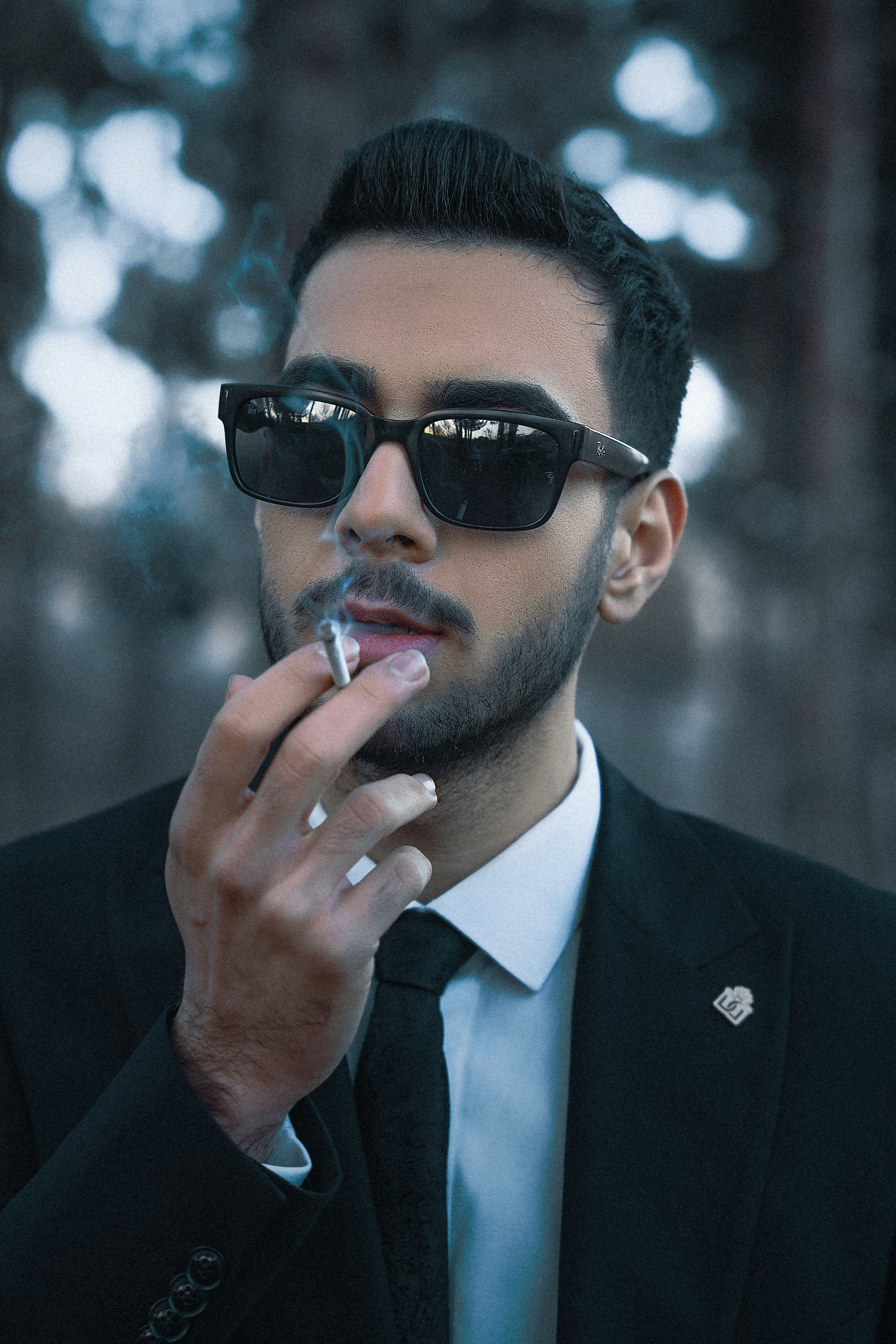 A man in a suit smoking a cigarette photo – Free Man Image on Unsplash