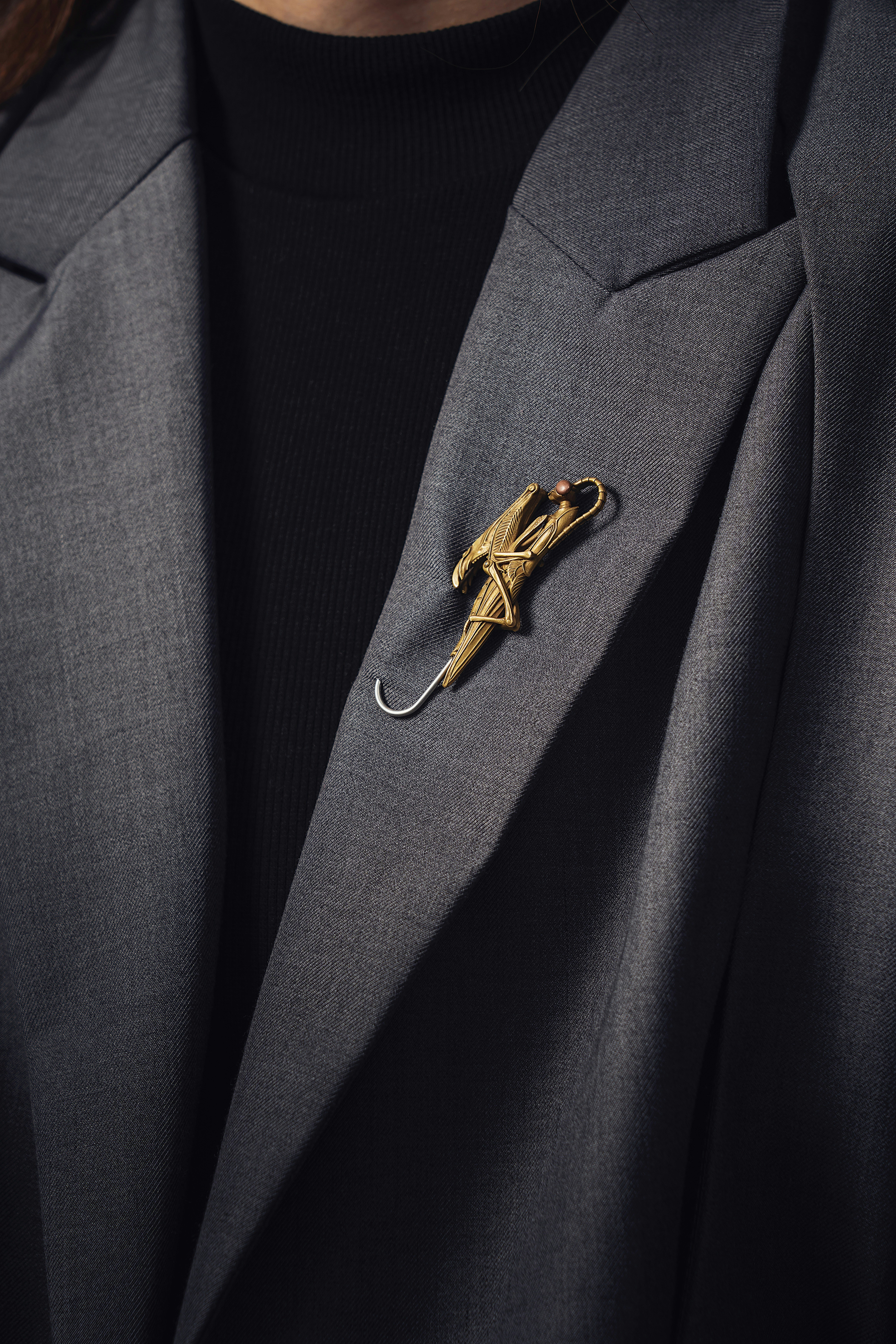 Gold Knot Brooch on a Charcoal Lapel: A Moment of Quiet Detail