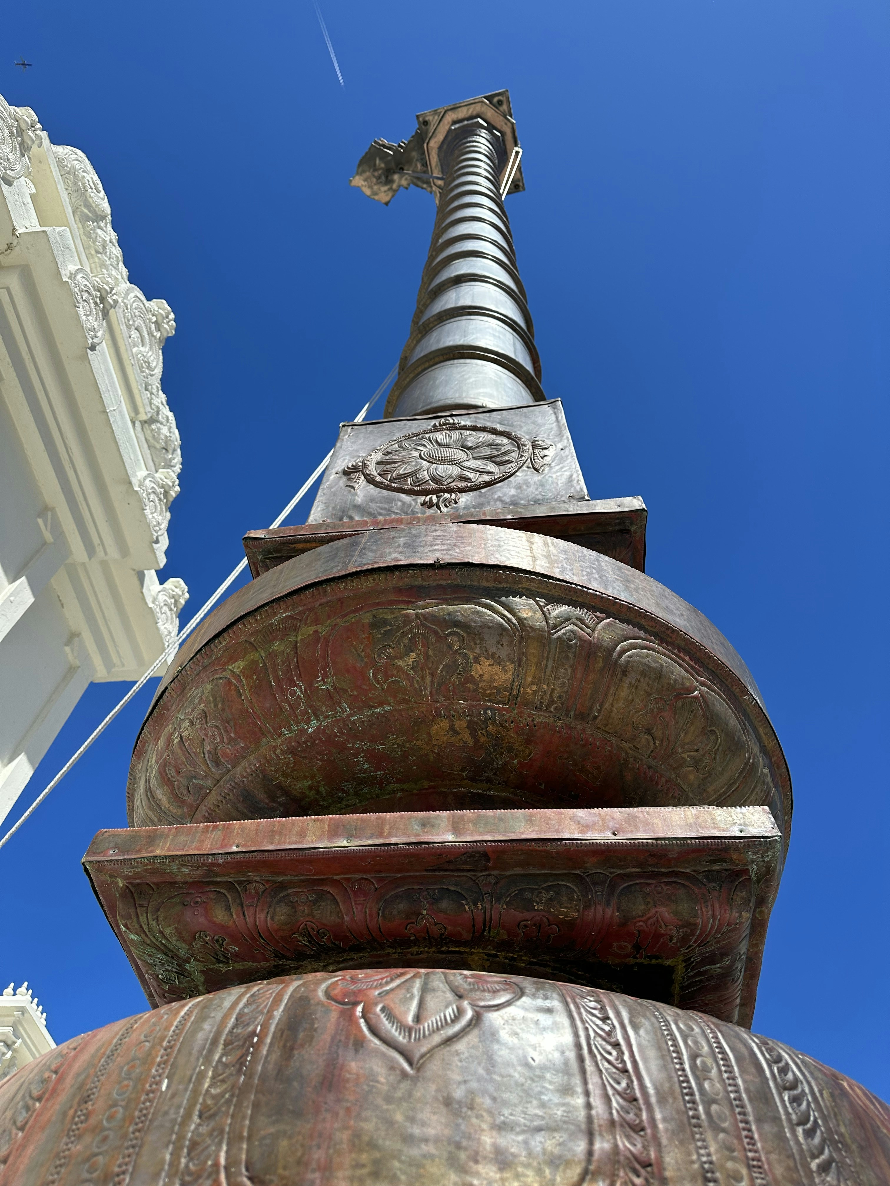 A very tall metal pole next to a building photo – Free Building Image ...