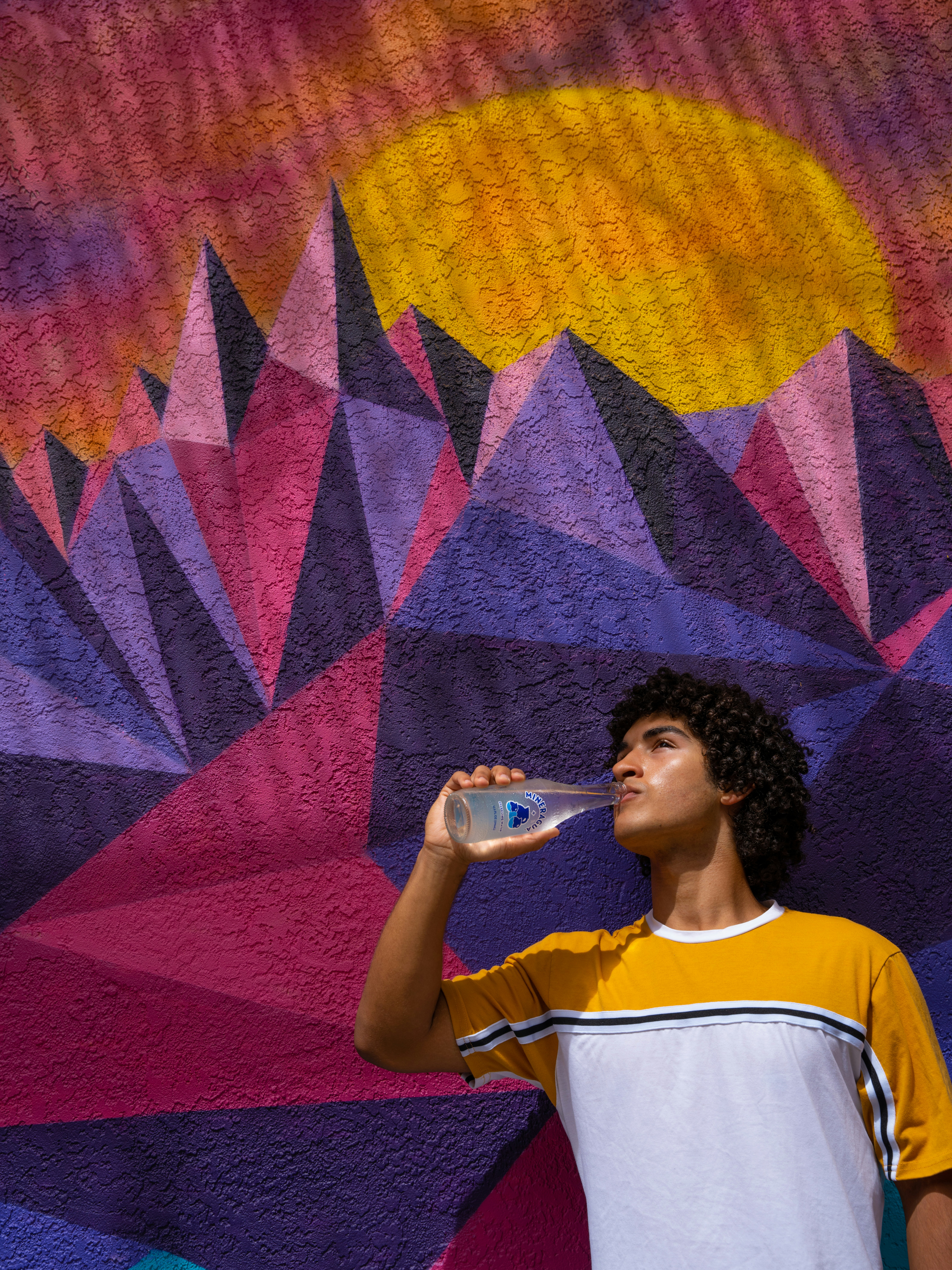 Quenched in Color: Portrait Before a Geometric Desert Sunset Mural