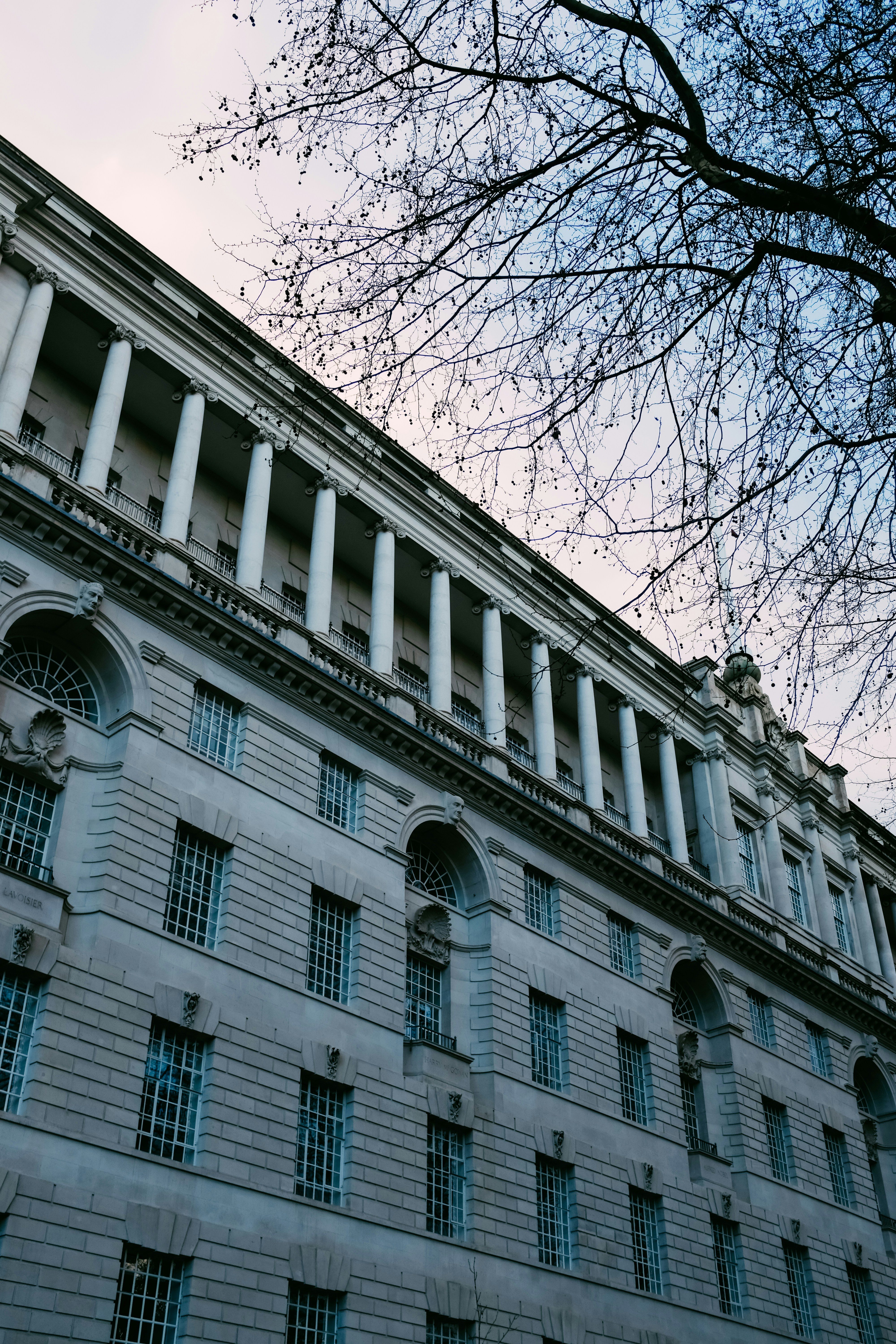Ascending Columns and Arches: A Neoclassical City Facade in Winter Light