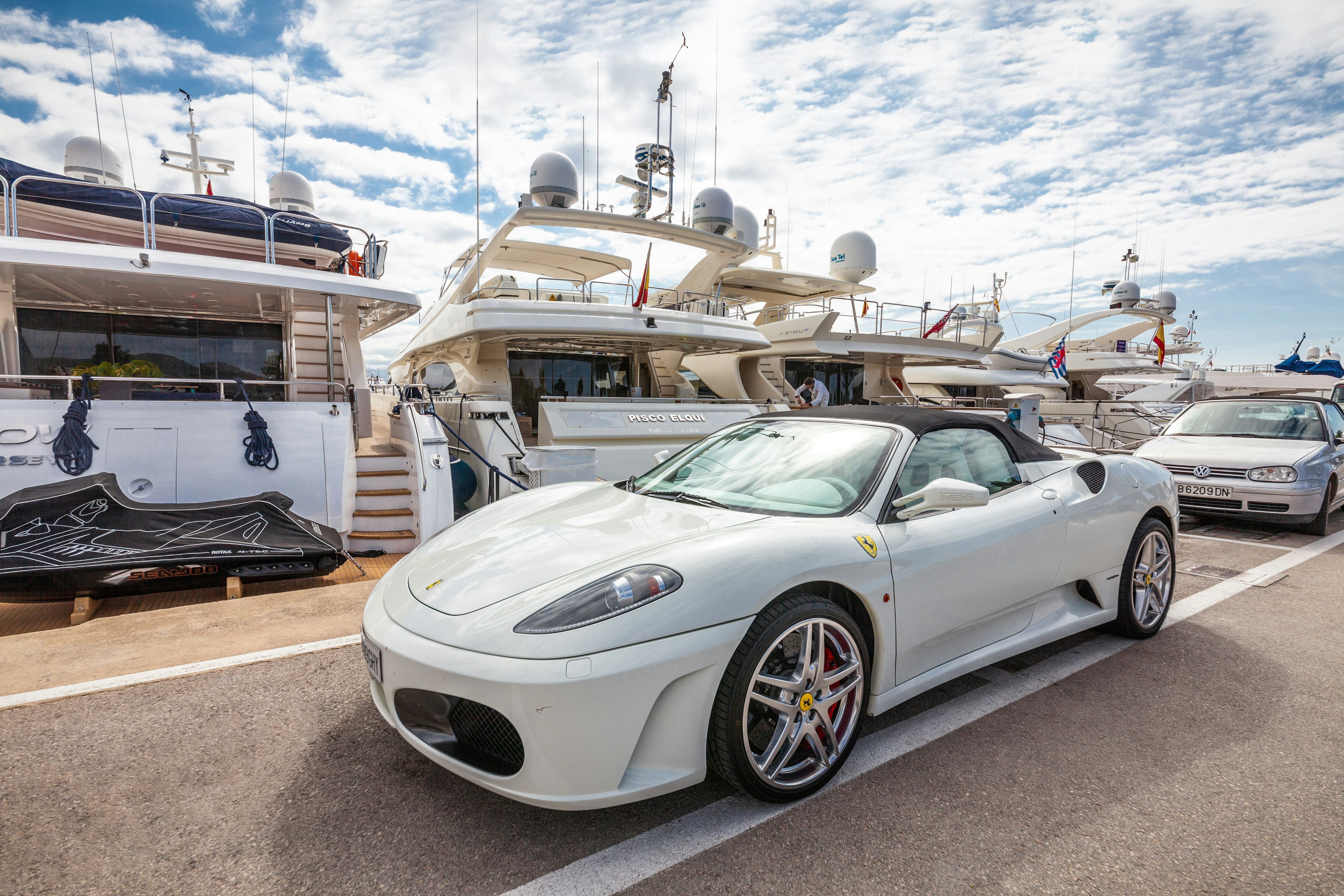 White Ferrari at the Marina: Luxury Power in a Sunny Dock