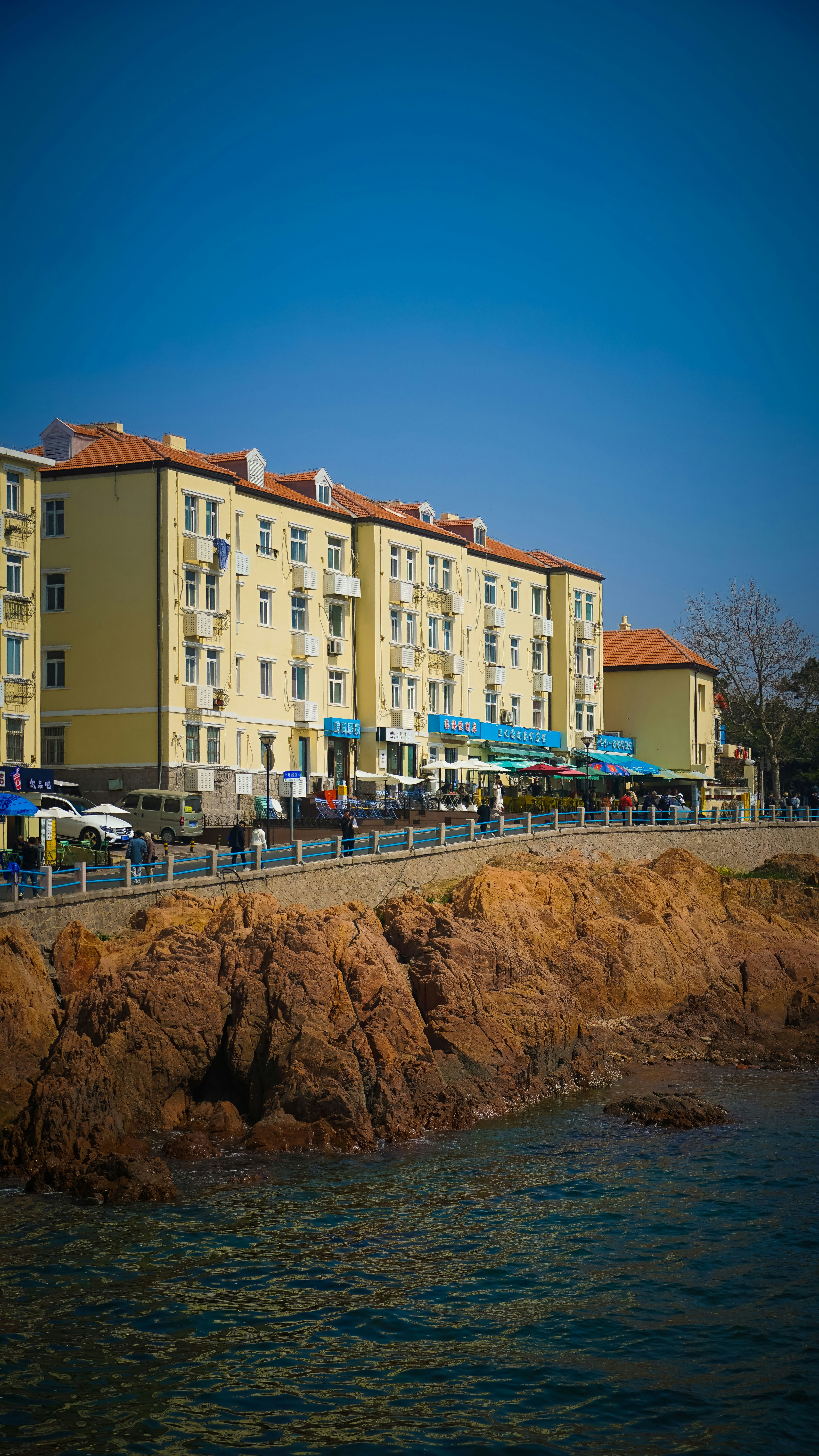 a large yellow building next to a body of water