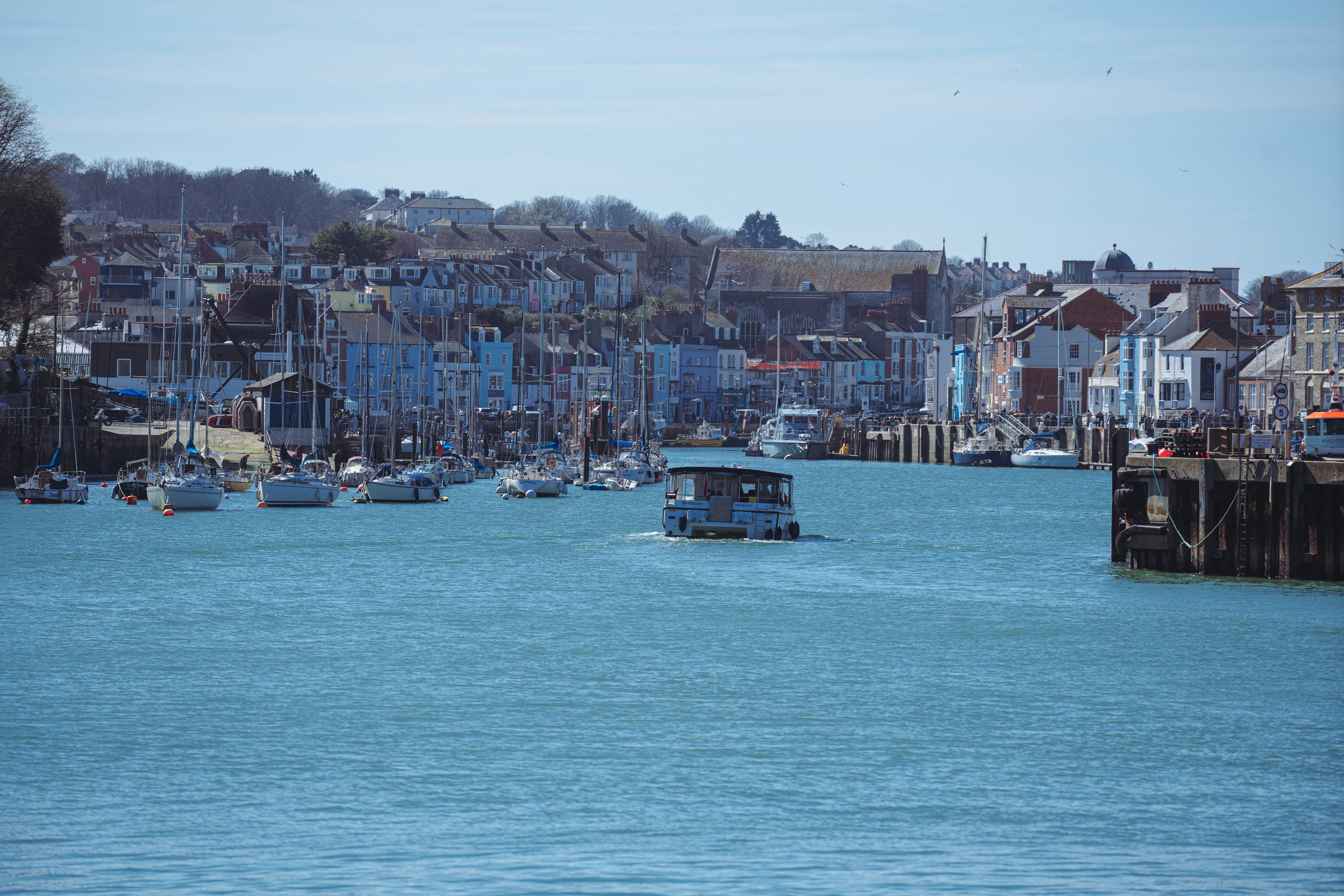 Cerulean Channel: Sailboats, Quay, and a Quiet Harbor