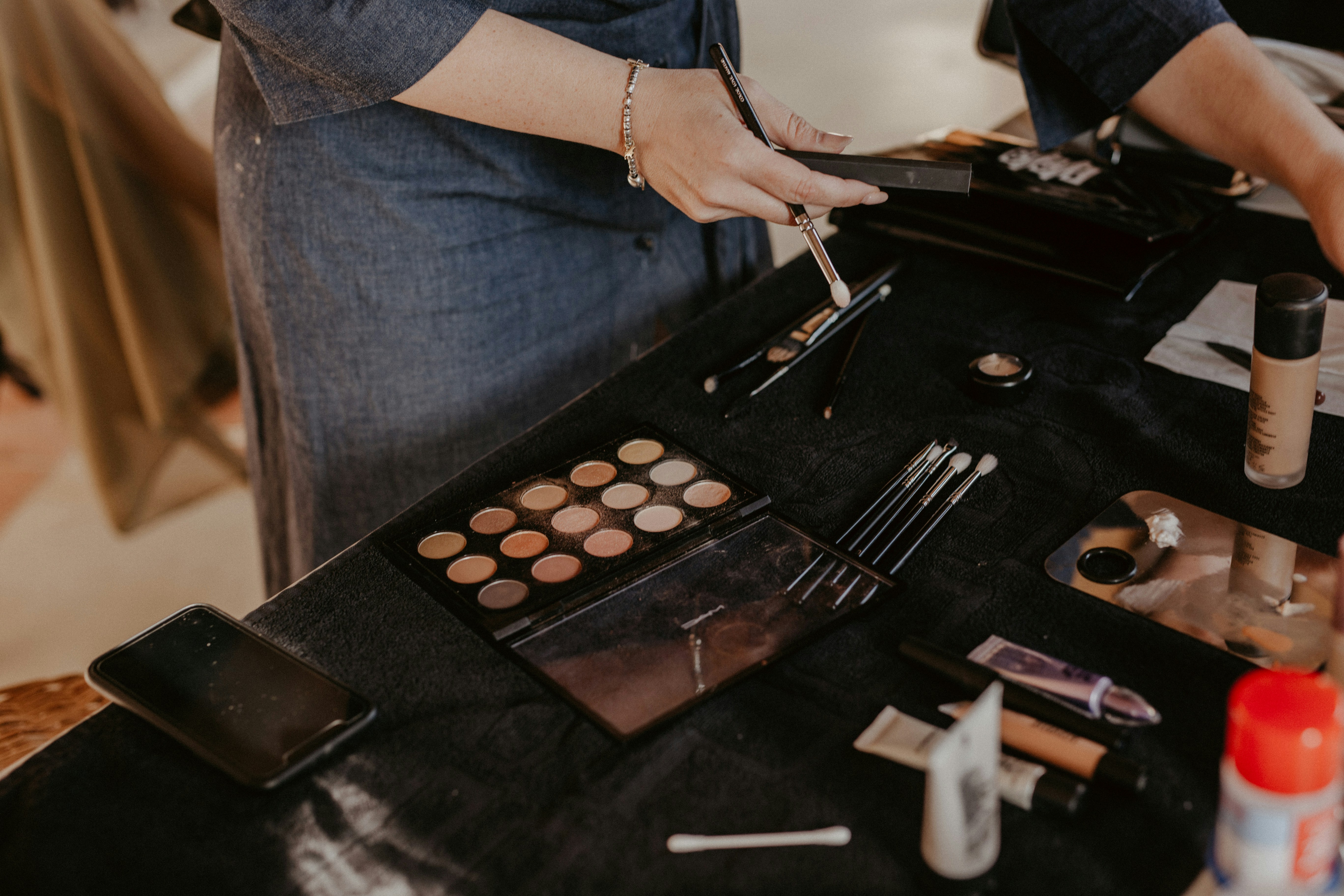 A woman is putting makeup on a table photo – Free Wedding ritual Image ...