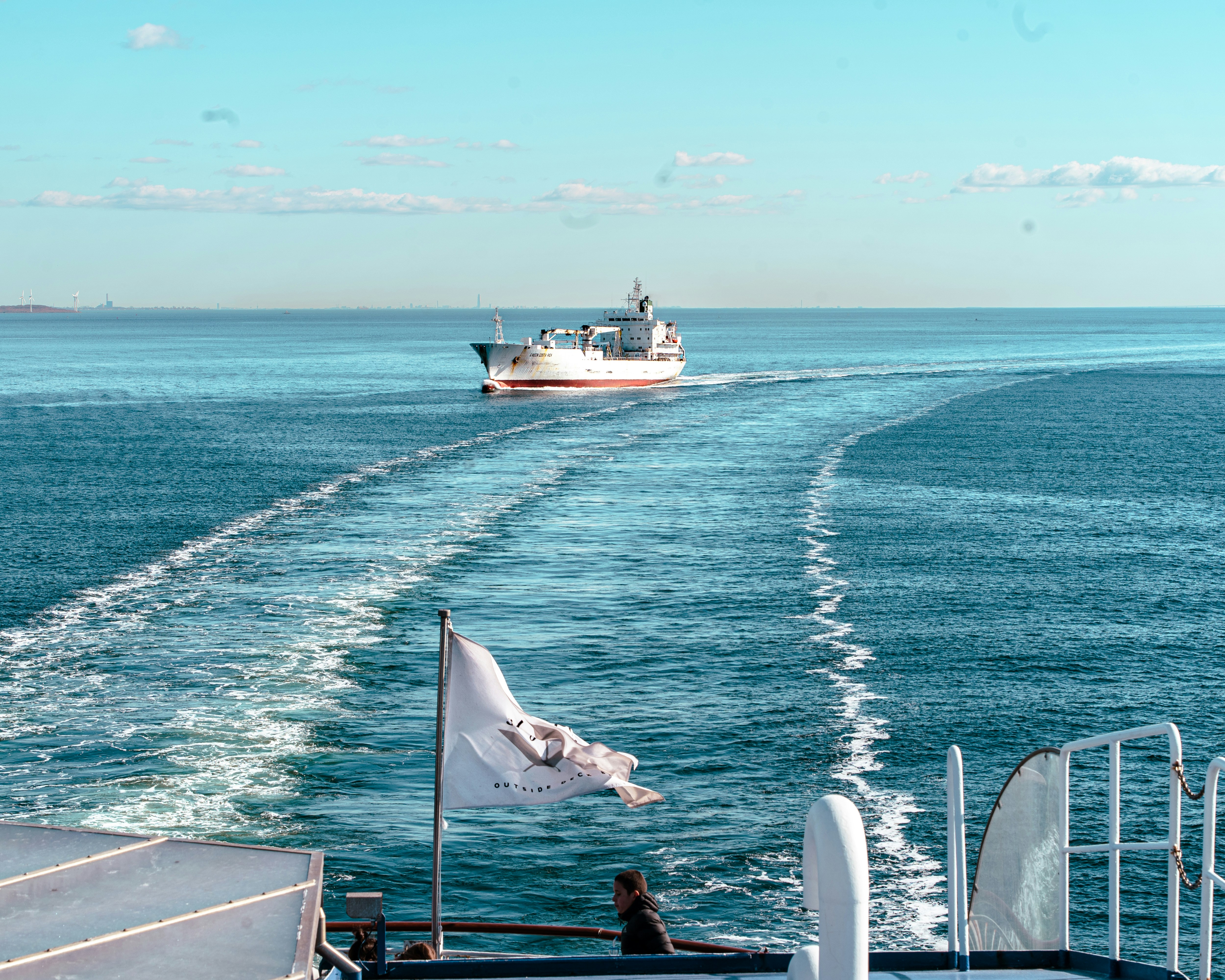 A boat traveling across a large body of water photo – Free Sea wave ...