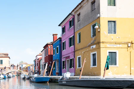 Vibrant Canal Front: Painted Townhouses Reflect on the Water