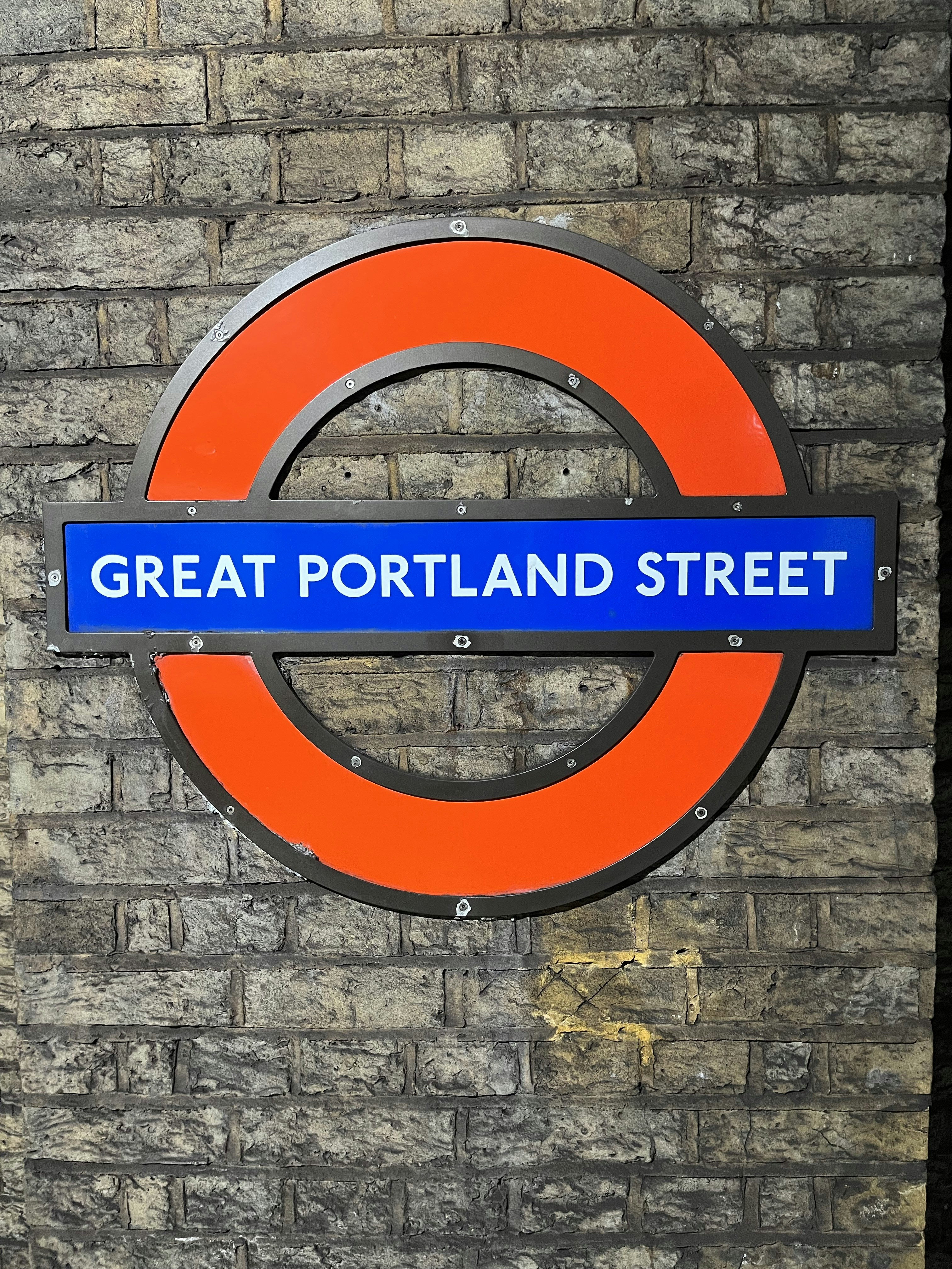 Underground Emblem: The Great Portland Street Roundel on Bricked Wall